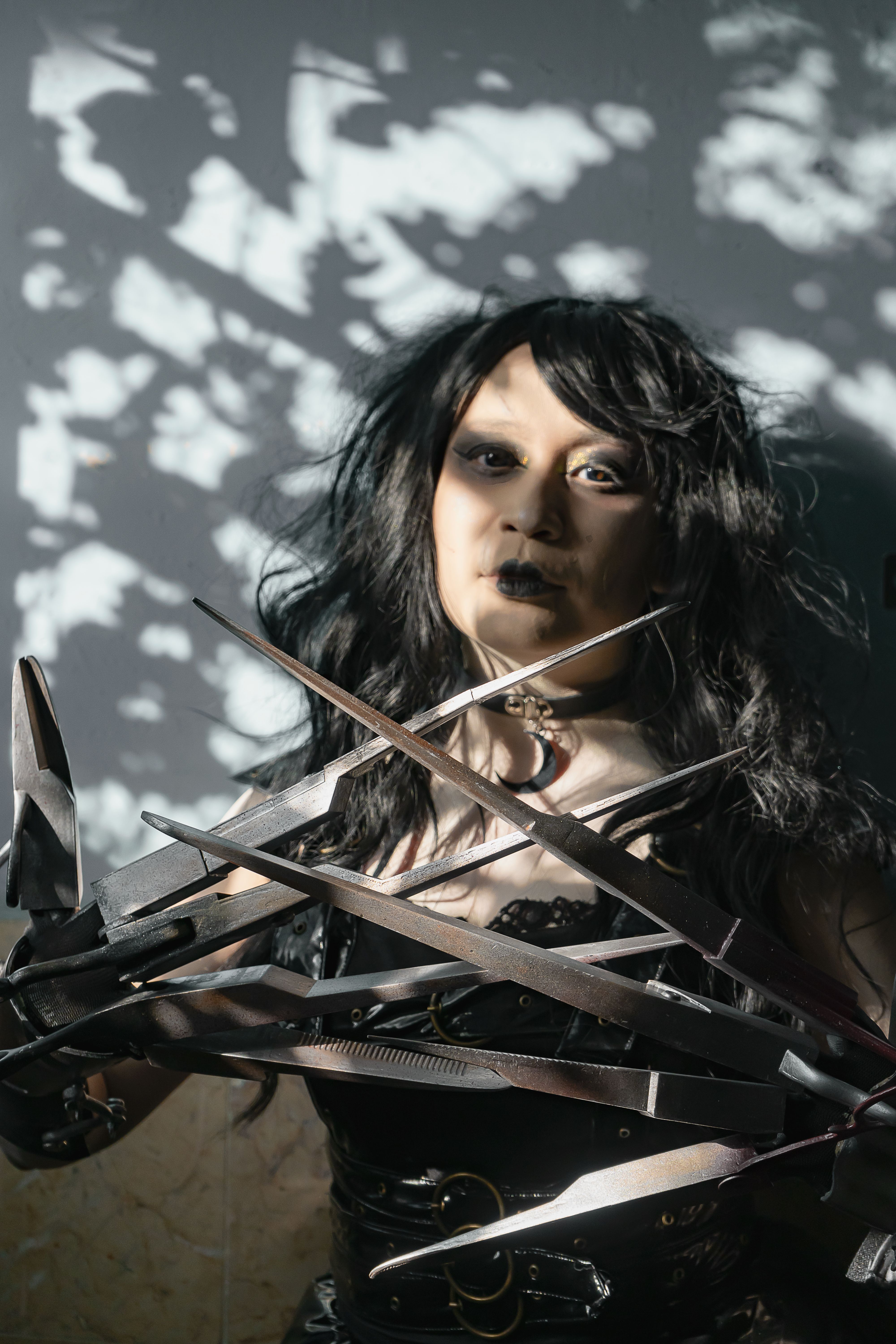Gothic Costume with Blade-Like Hands in Shadow · Free Stock Photo