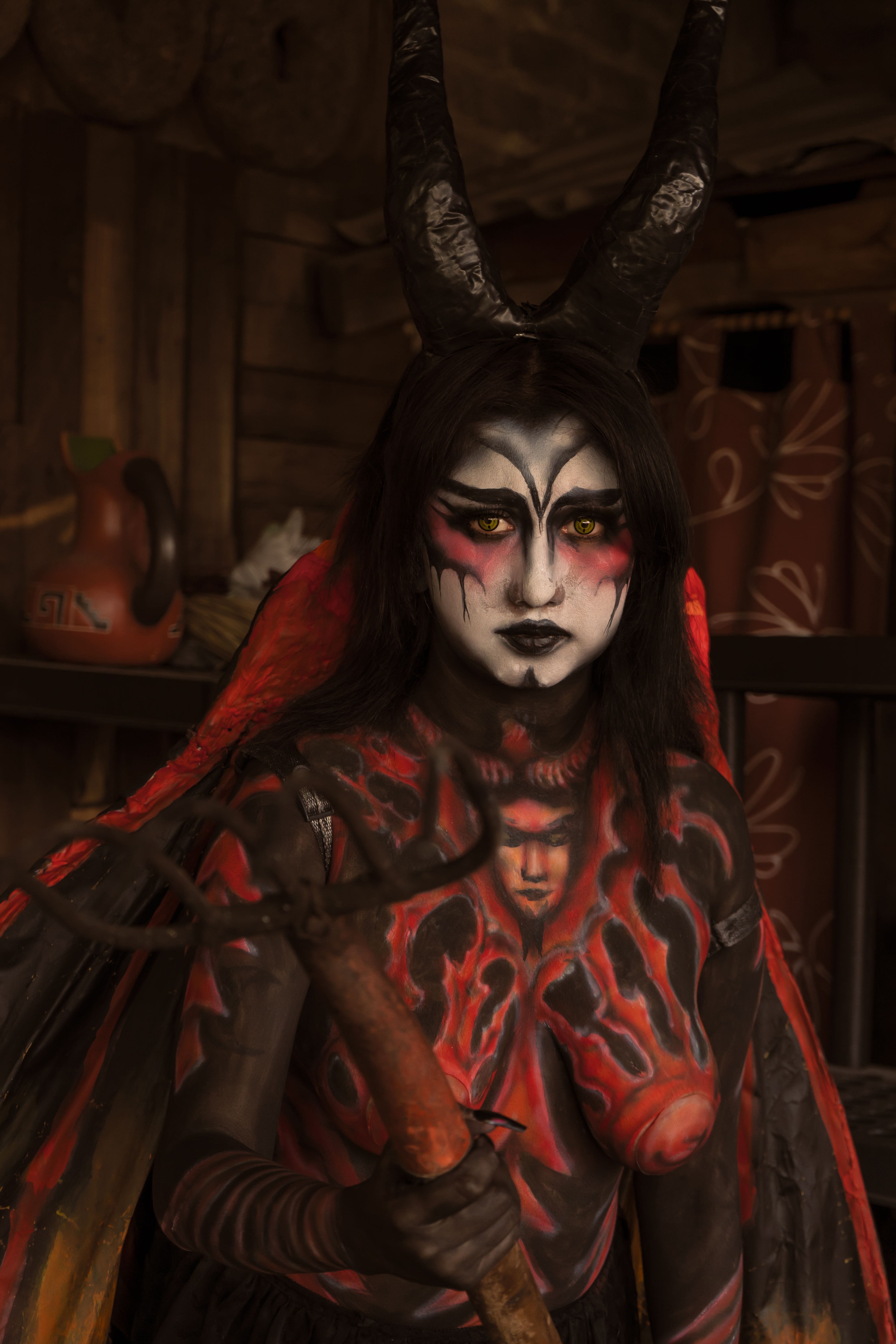 Dramatic Demon Costume in Dimly Lit Room · Free Stock Photo