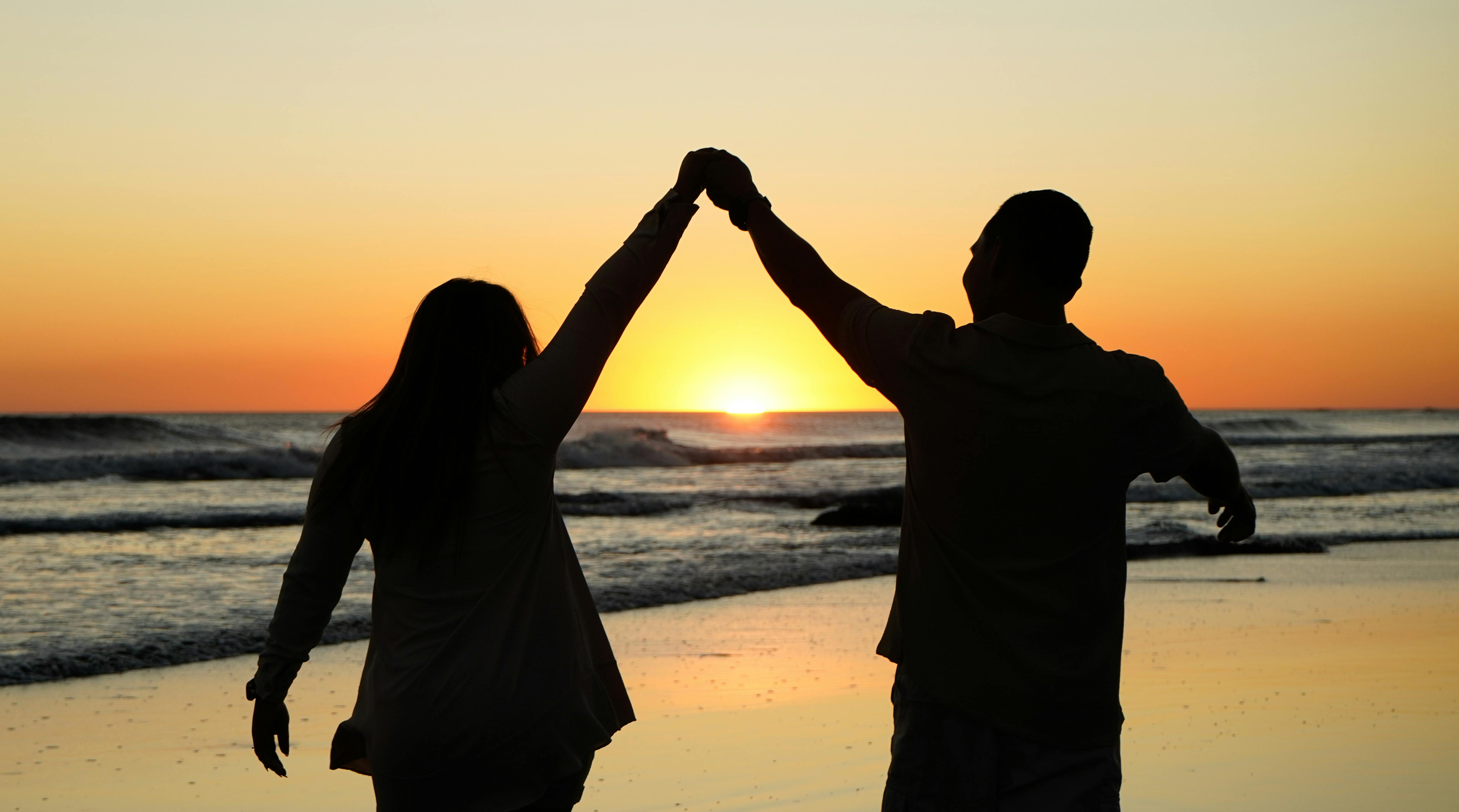 Romantic Couple Dancing at Sunset on the Beach · Free Stock Photo