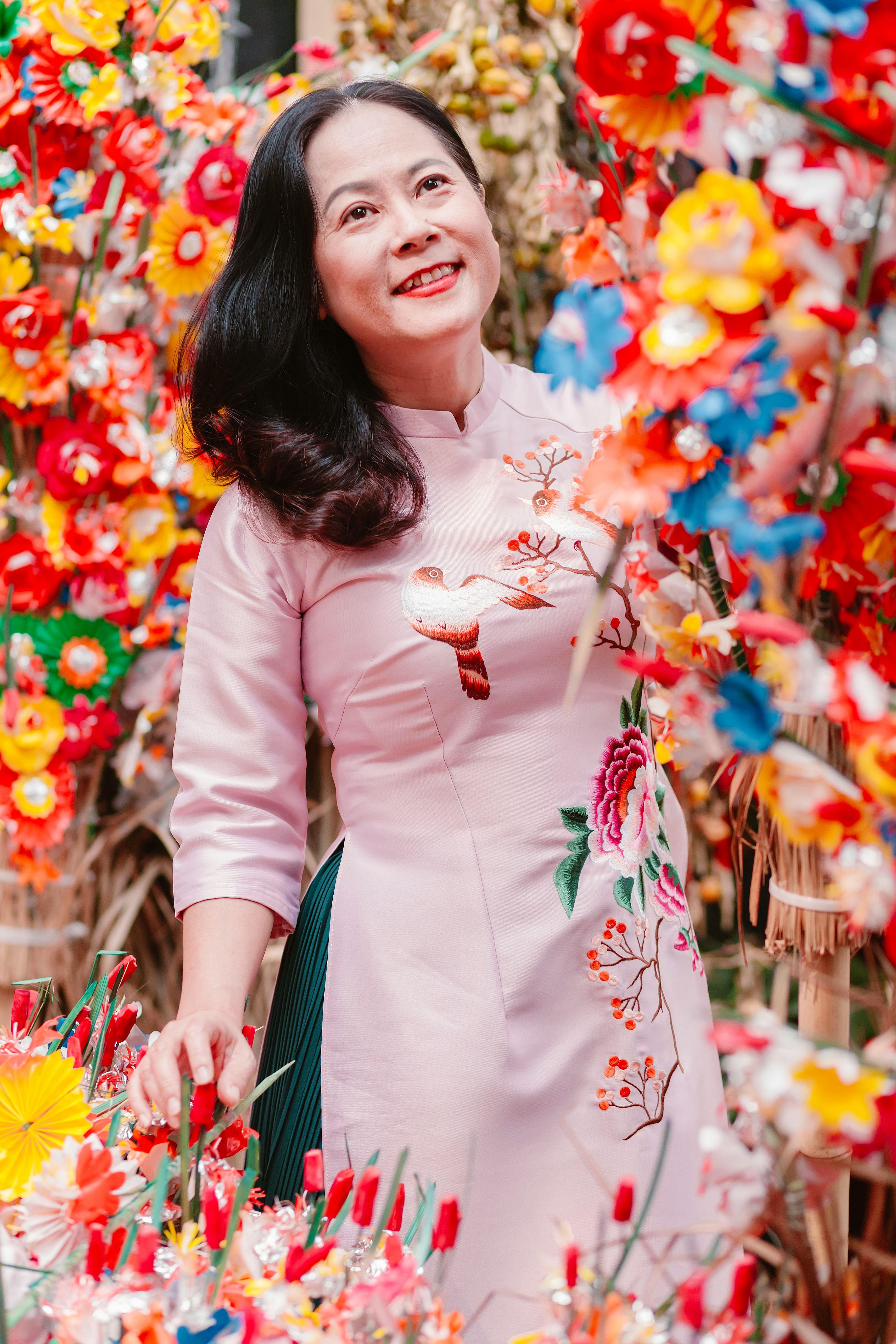 Woman in Traditional Dress Amidst Colorful Flowers · Free Stock Photo