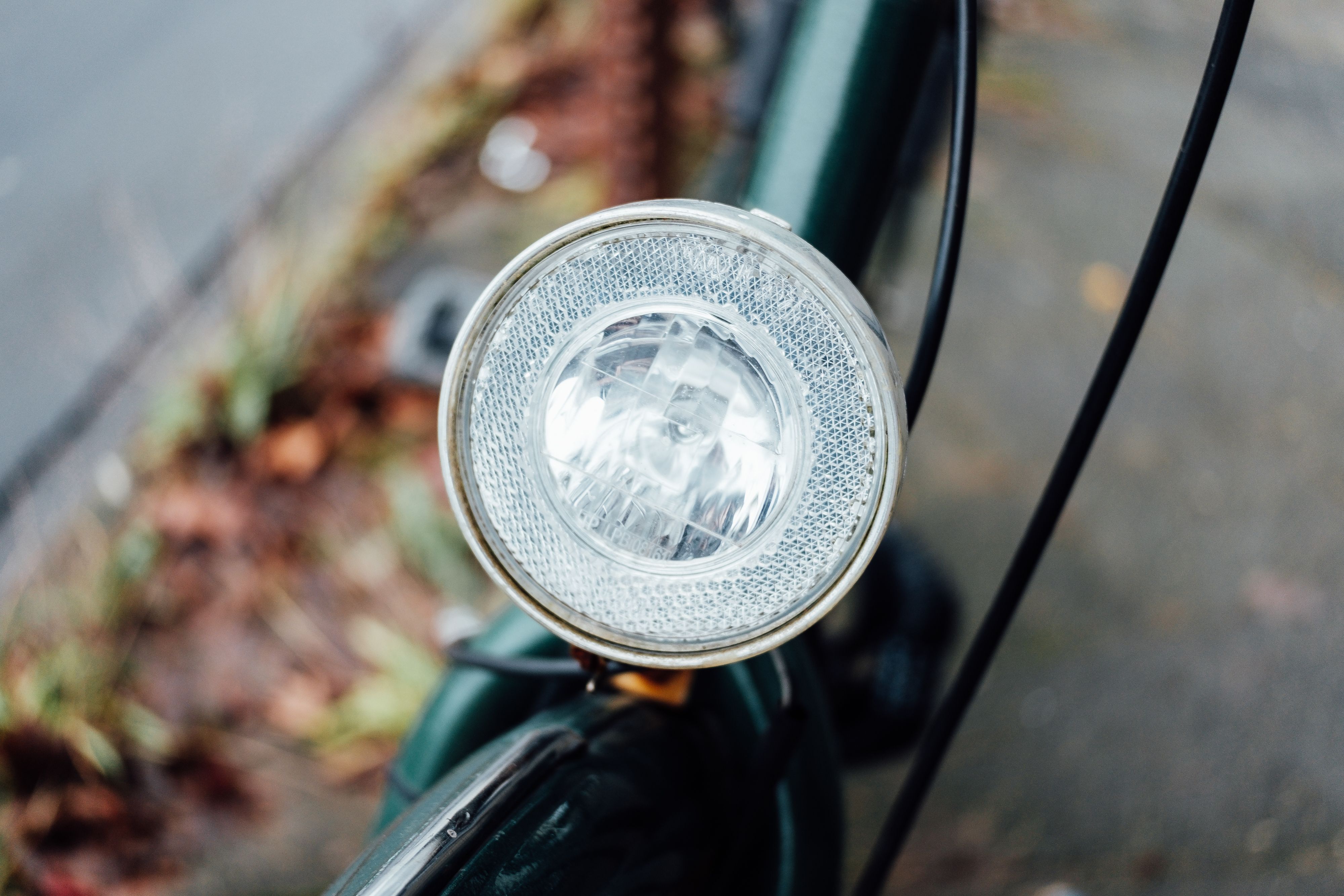 Close-up of Bicycle Headlight in Urban Setting · Free Stock Photo