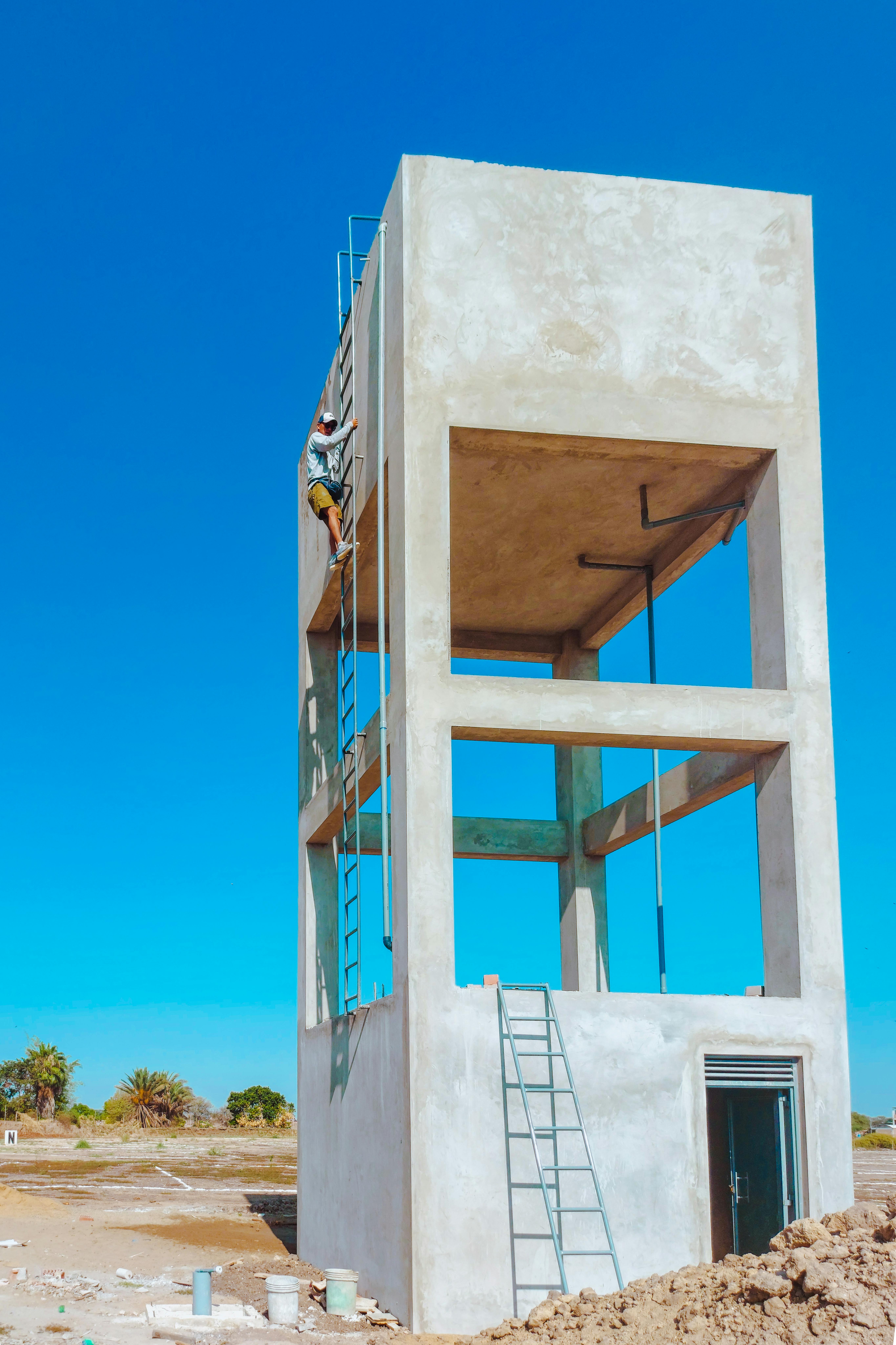 Construction Worker on Water Tower in Peru · Free Stock Photo