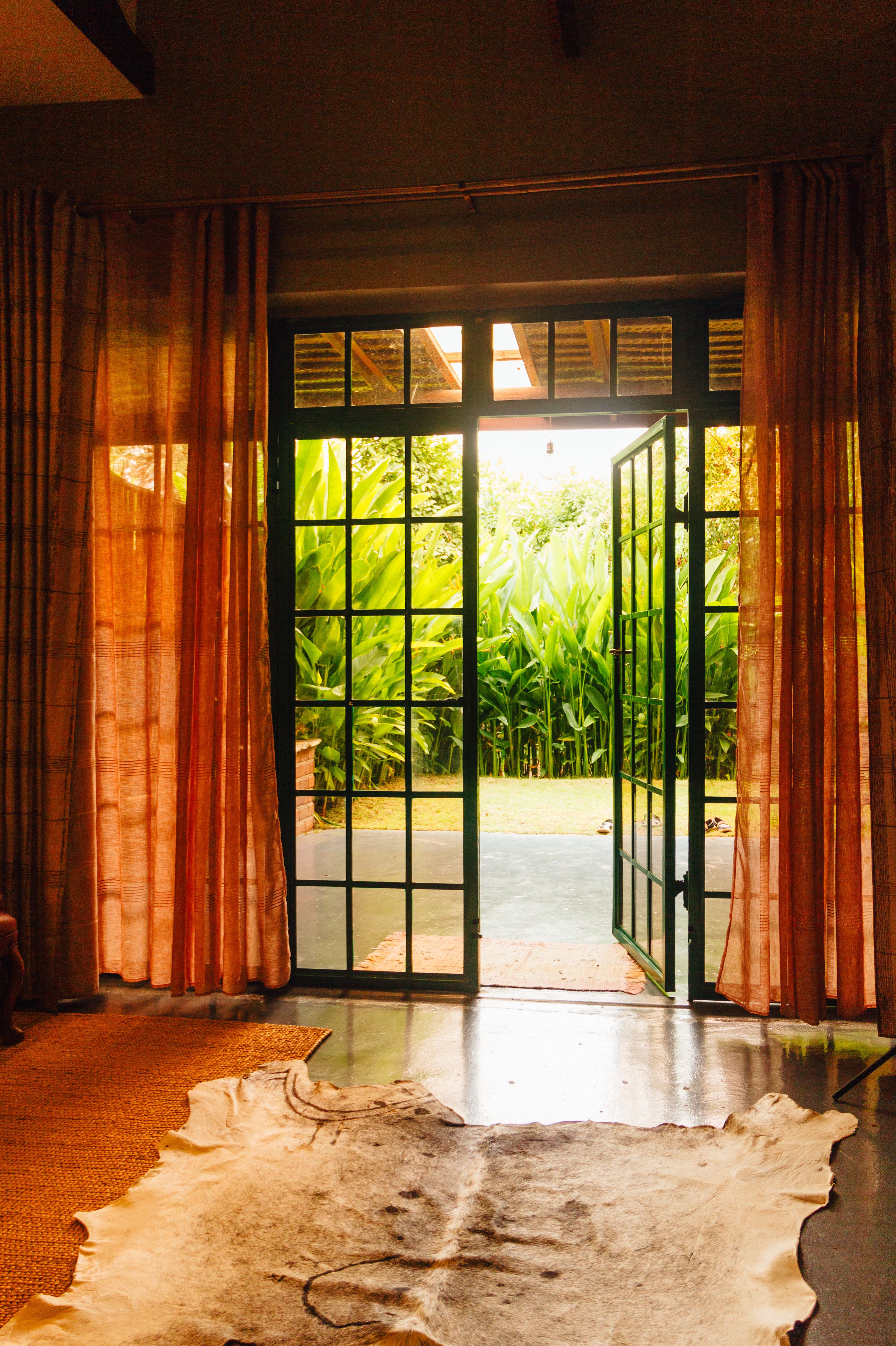 Cozy Interior with Open Patio Doors Overlooking Garden · Free Stock Photo