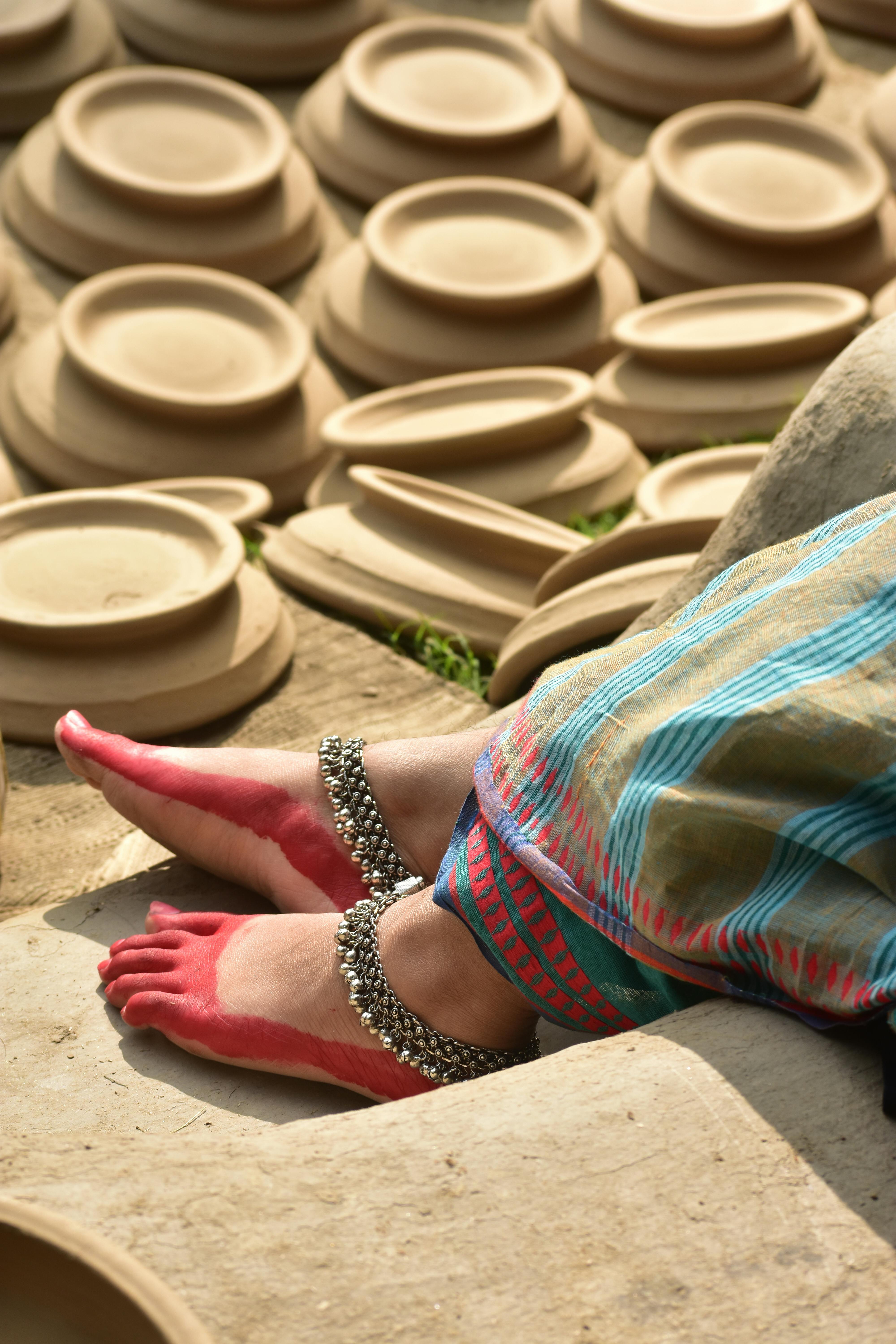 Traditional Pottery with Vibrant Painted Feet · Free Stock Photo