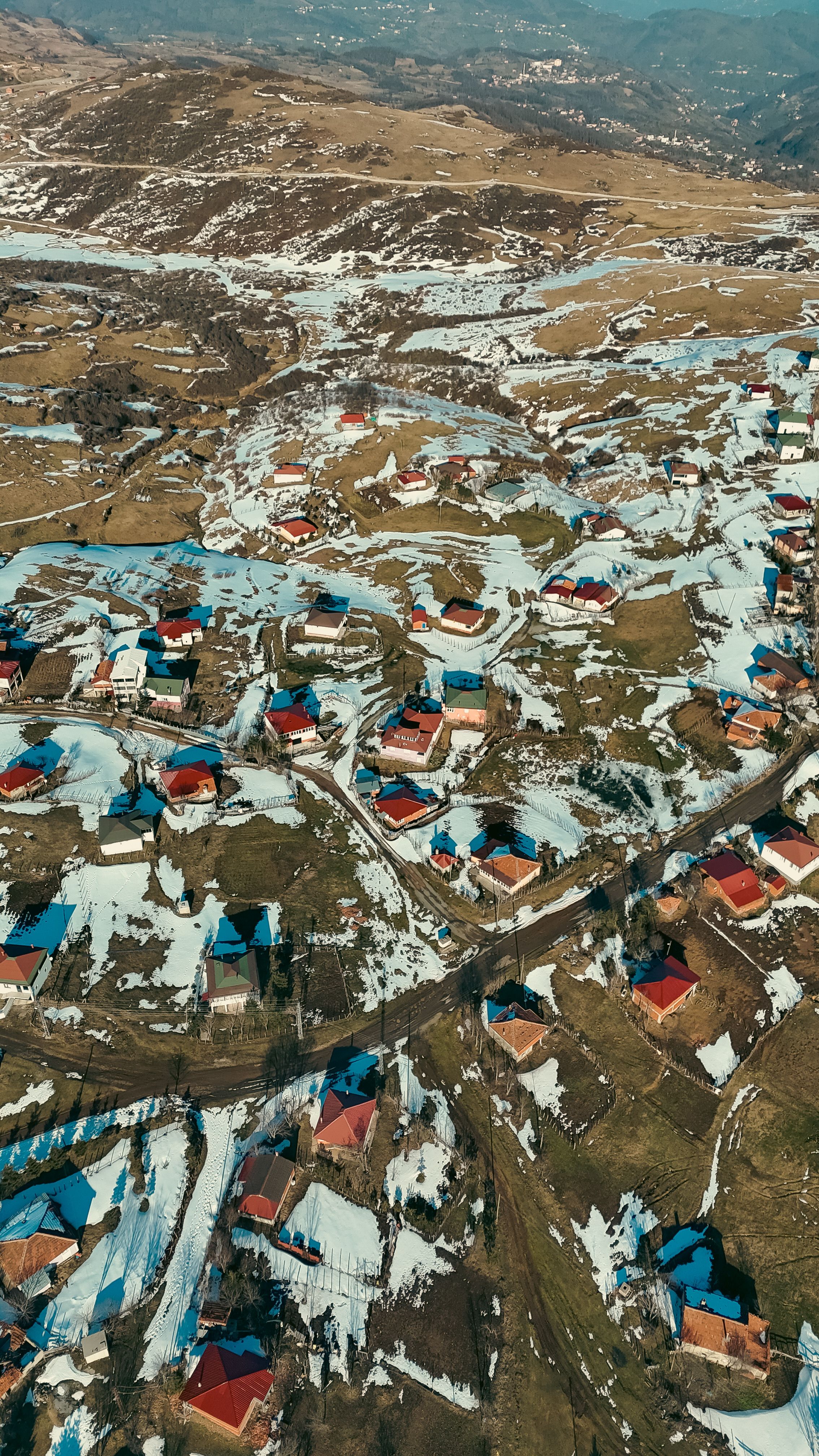 Aerial View of Snowy Village with Colorful Rooftops · Free Stock Photo