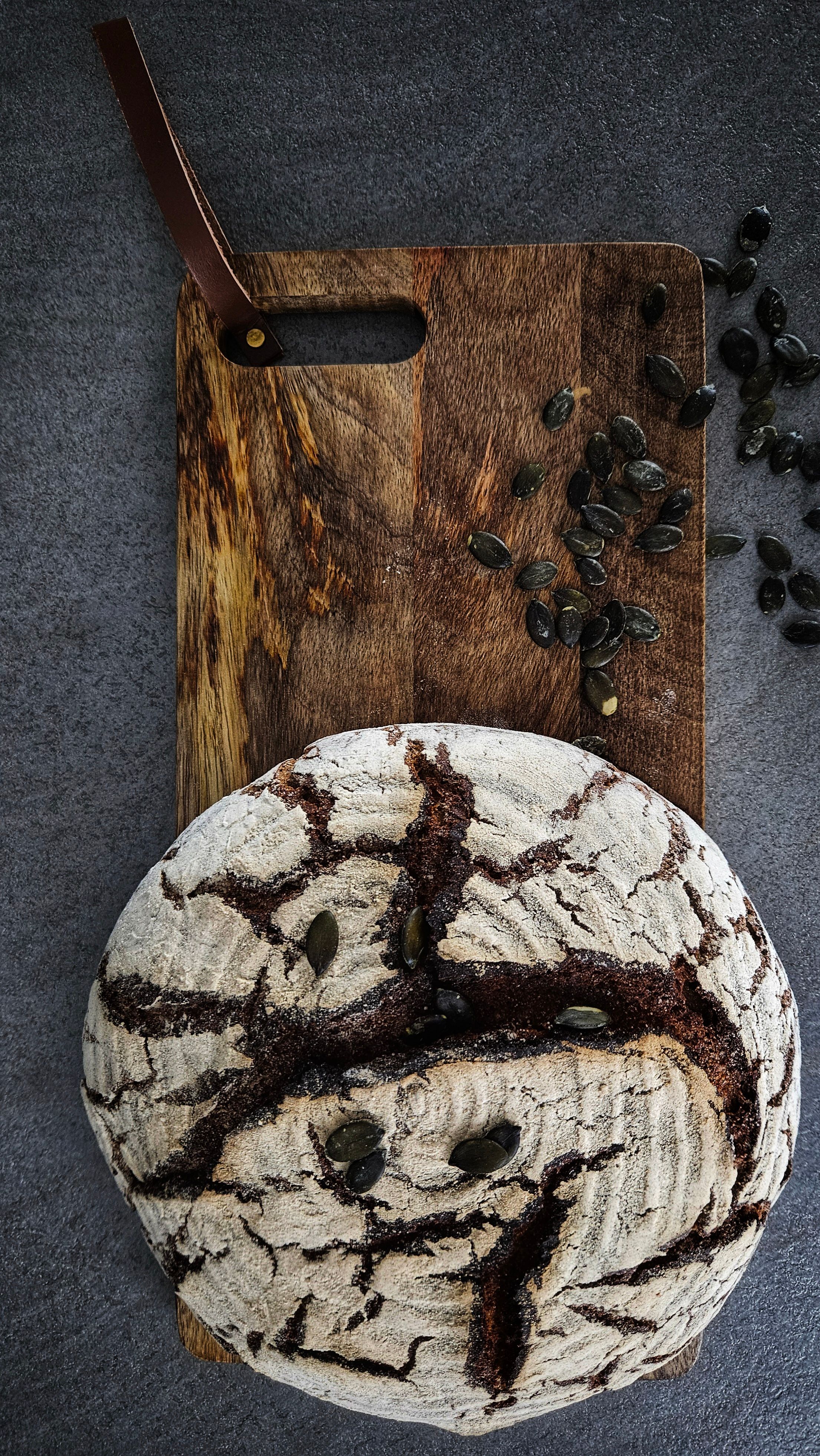 Rustic Seed-Topped Bread on Wooden Board · Free Stock Photo