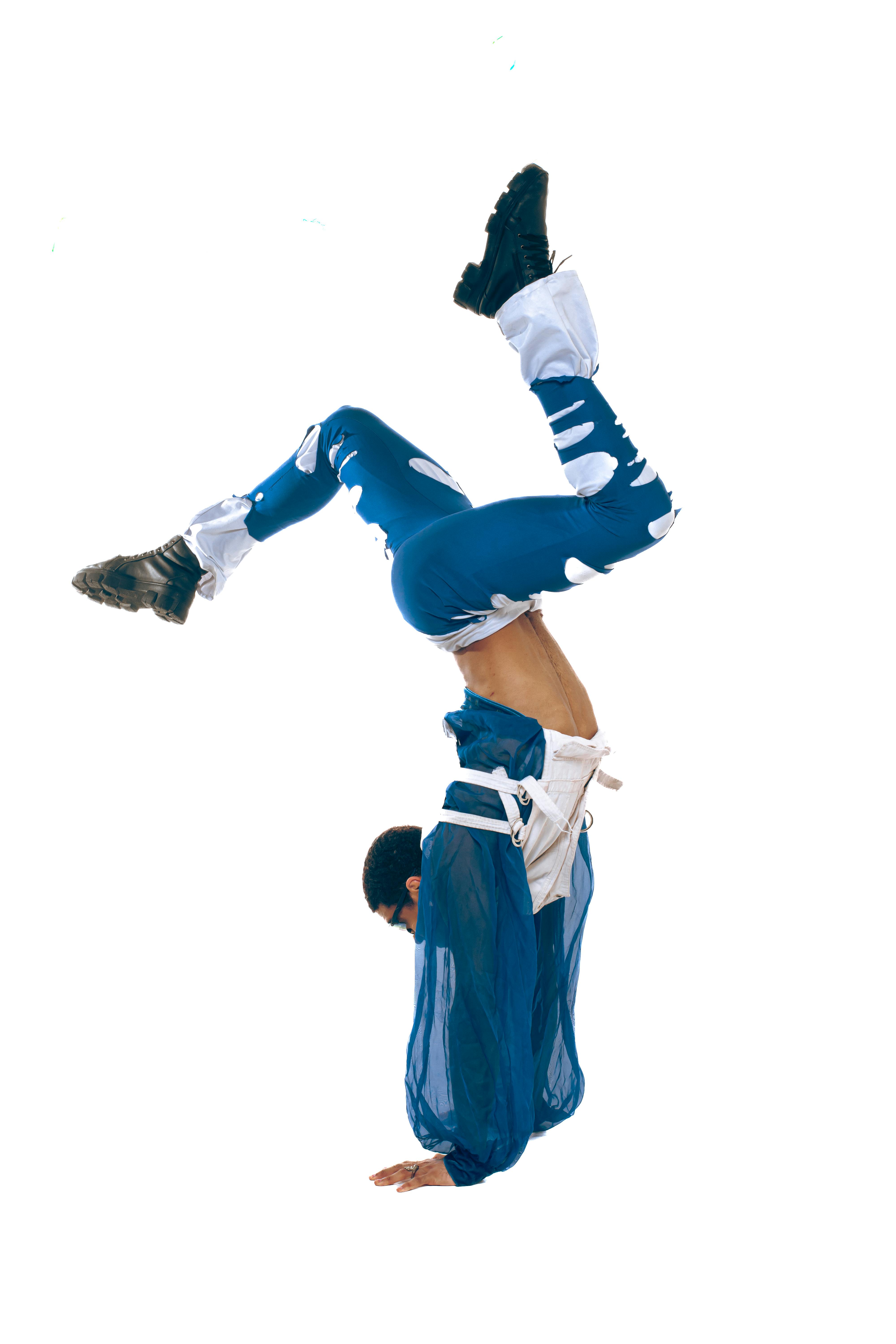Dynamic Acrobatics in Blue Costume · Free Stock Photo