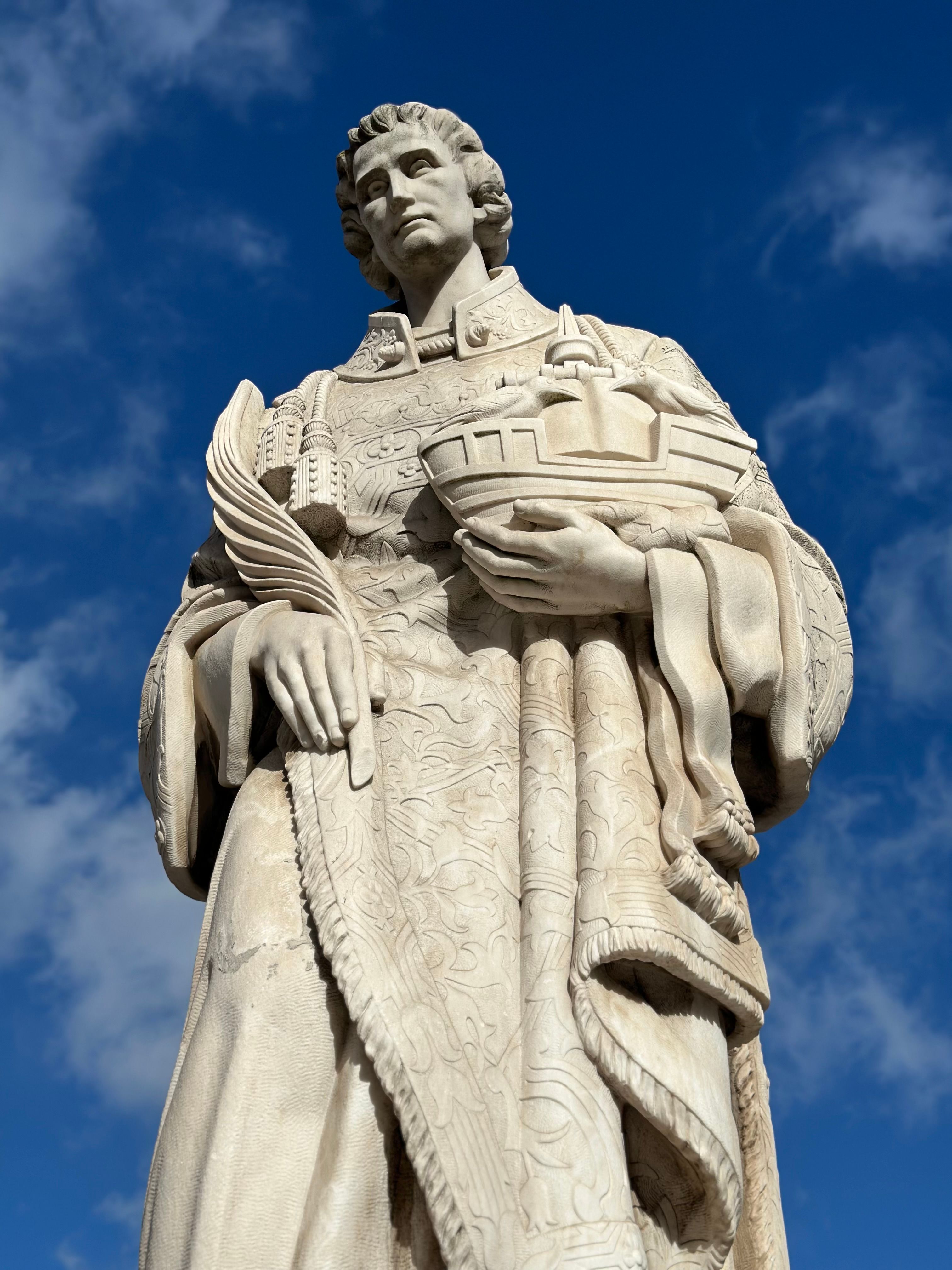 Majestic Stone Statue Against Blue Sky · Free Stock Photo