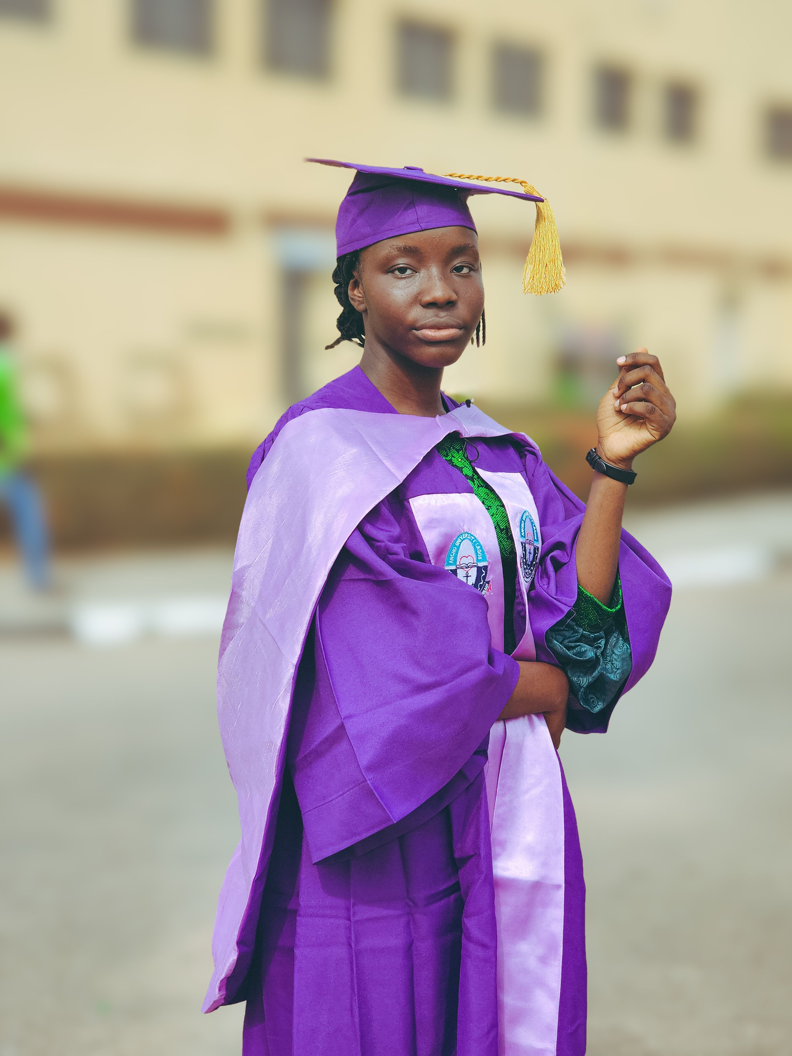 Proud Graduate in Purple Cap and Gown · Free Stock Photo