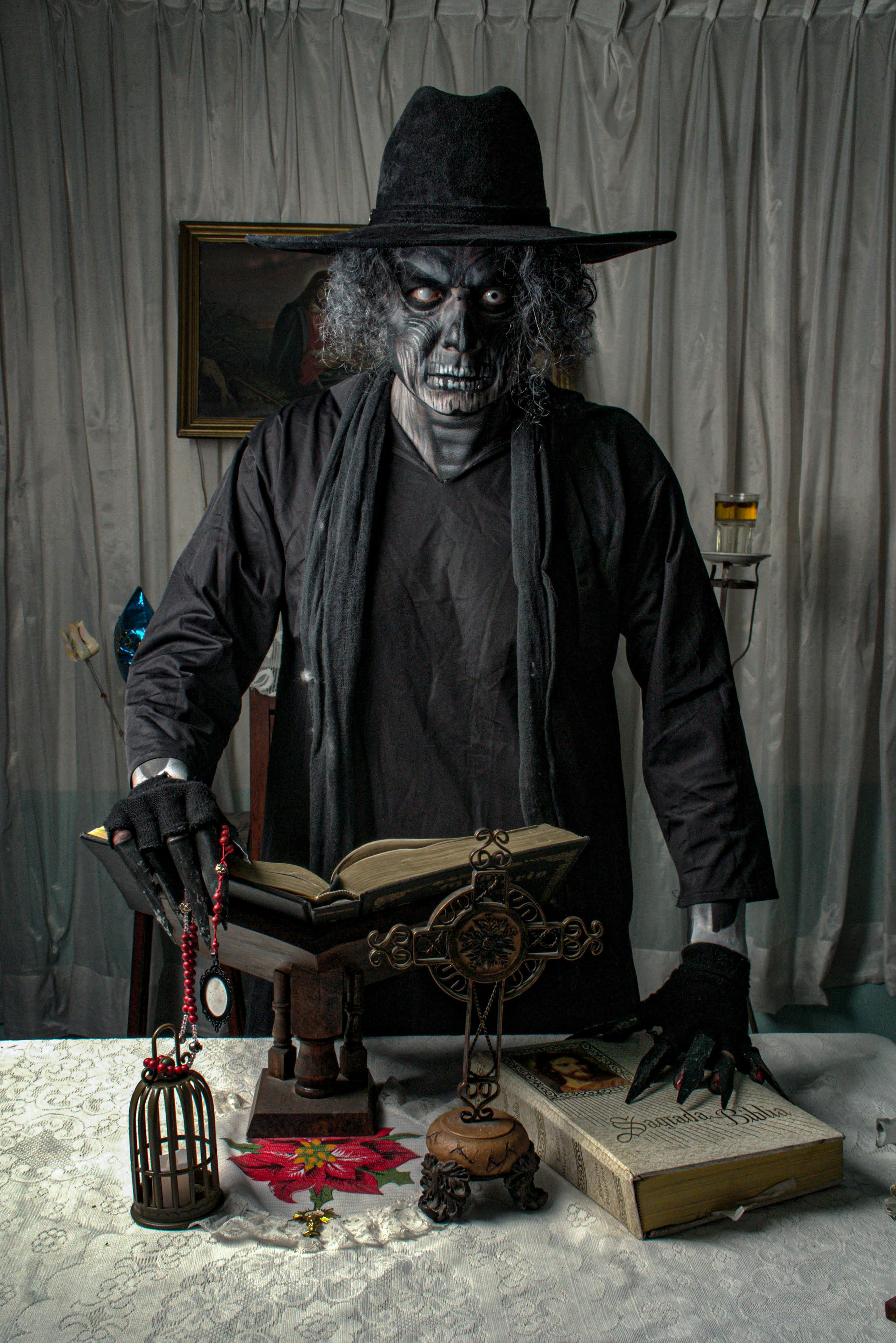 Mysterious Gothic Figure with Book and Cross · Free Stock Photo