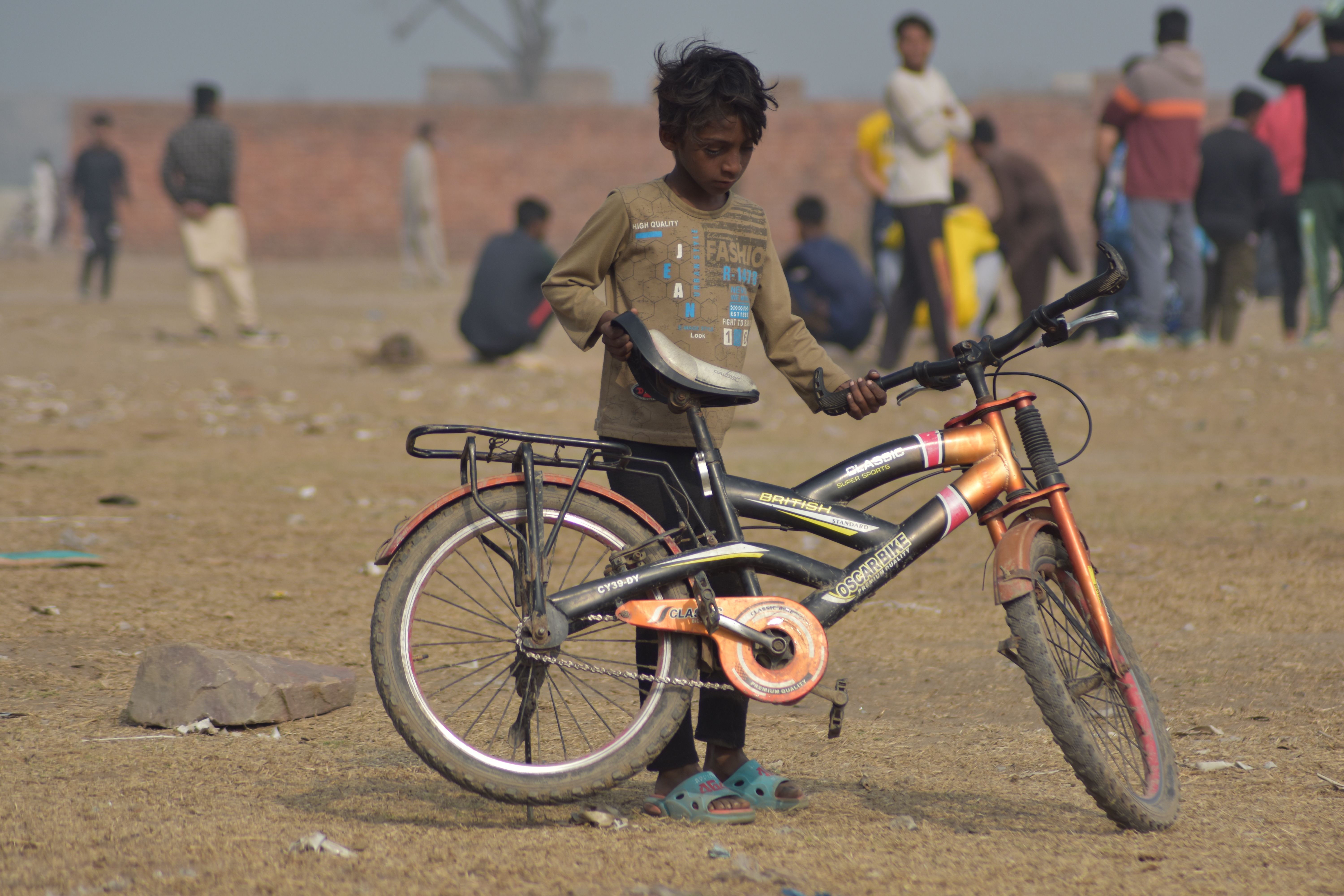 Child with Bicycle in Outdoor Setting · Free Stock Photo