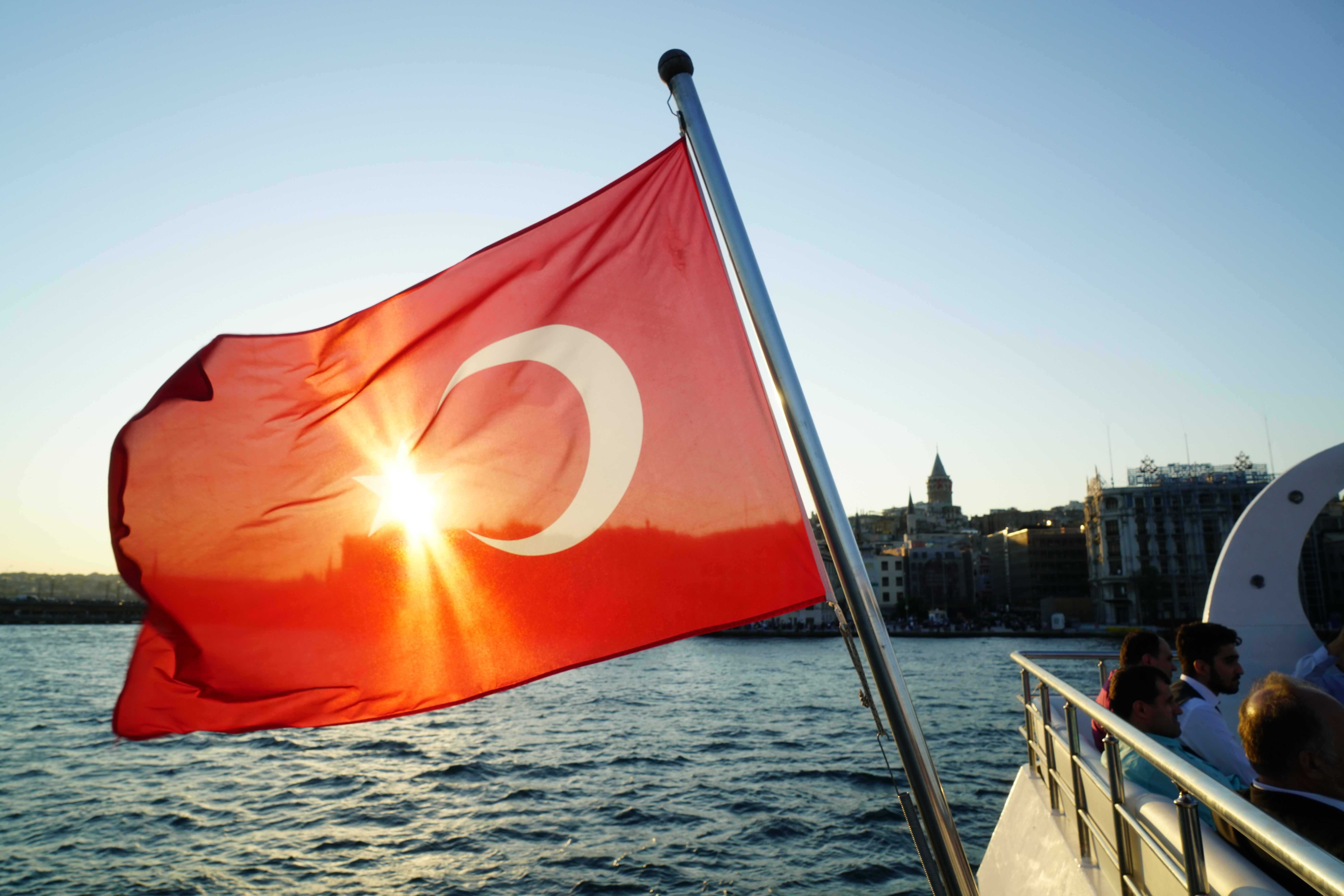 Turkish Flag Waves on Boat with Cityscape View · Free Stock Photo