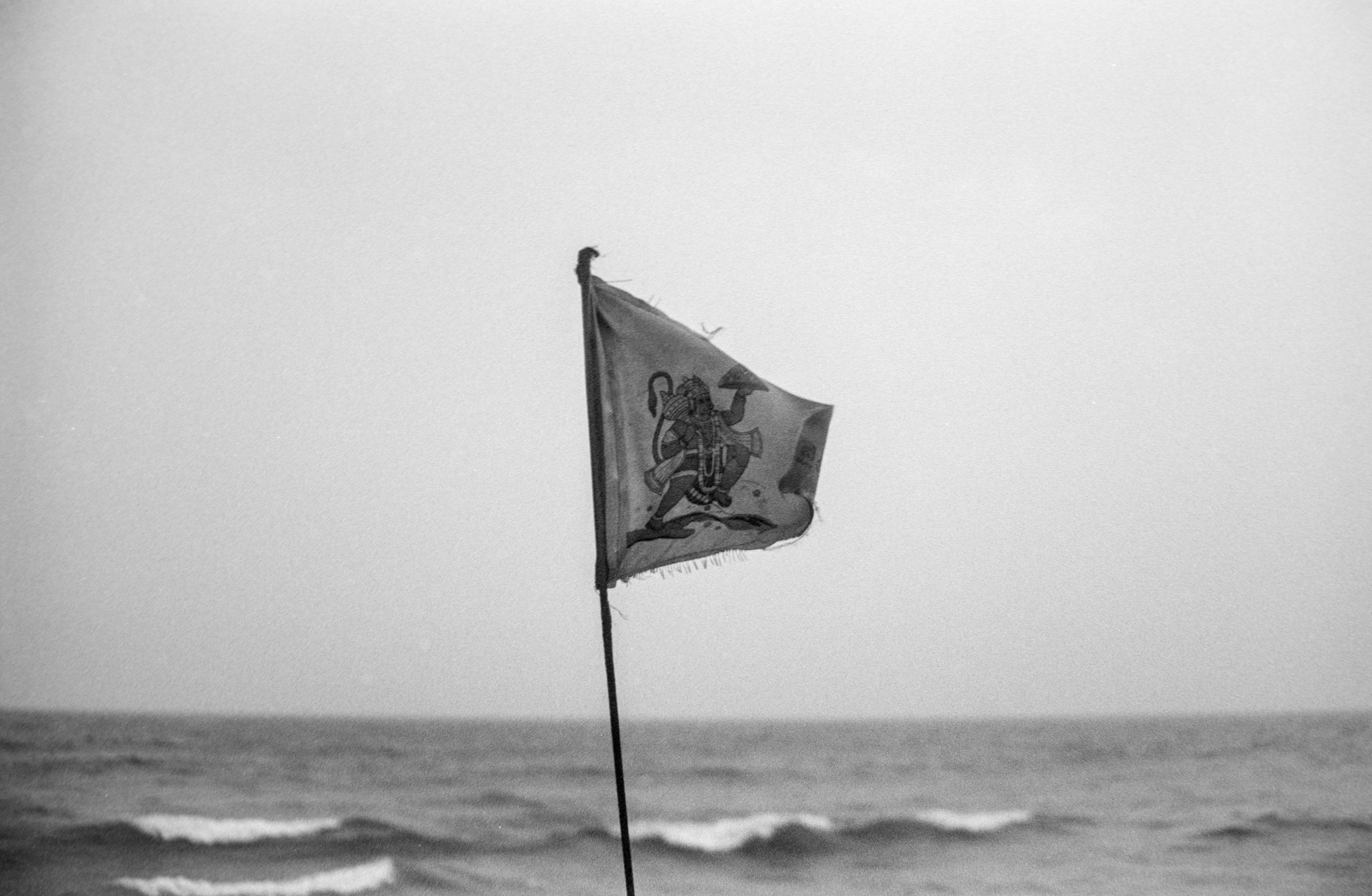 Flag with Hindu Deity Over Ocean in Andhra Pradesh · Free Stock Photo