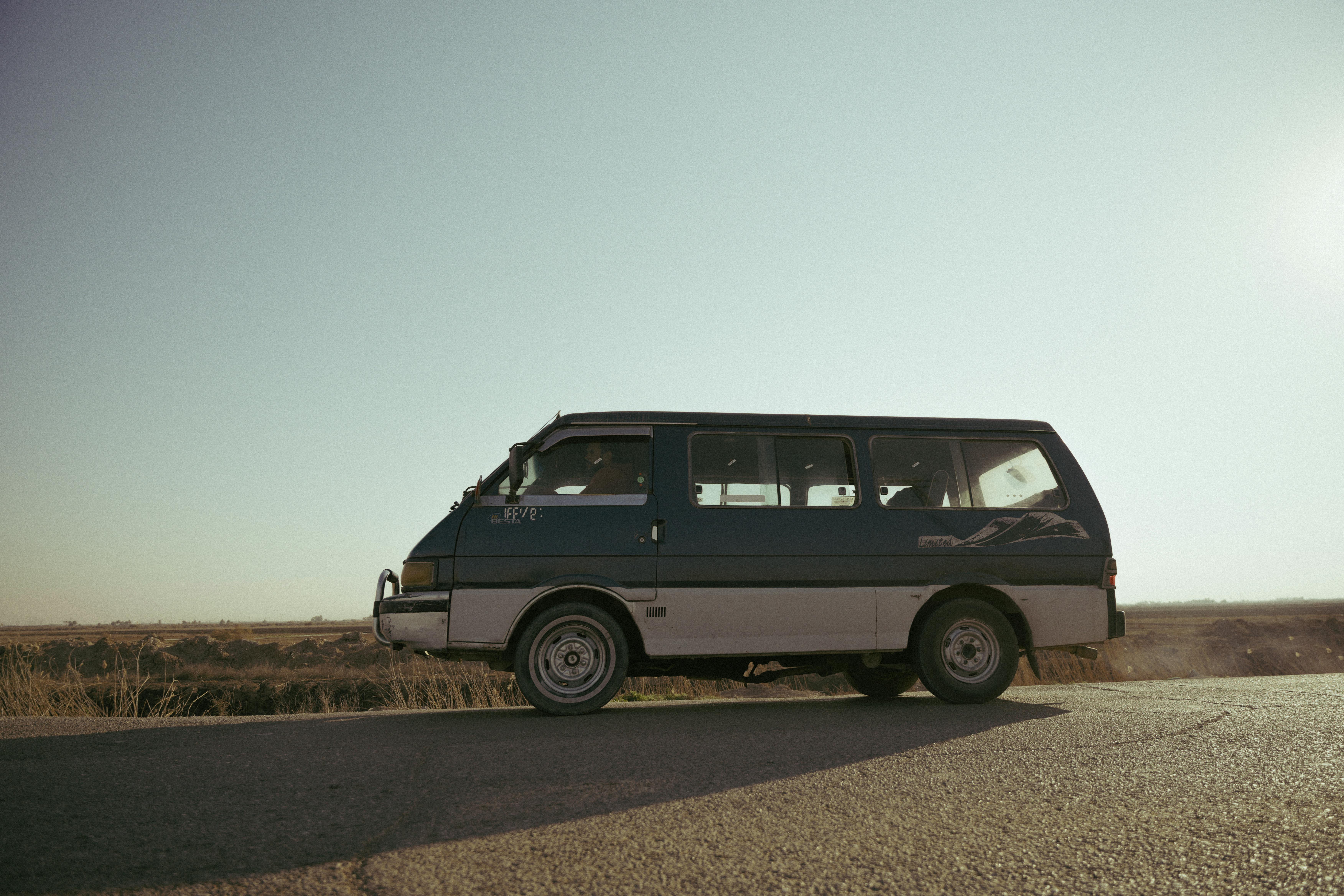 Vintage Minivan Parked on a Rural Roadside · Free Stock Photo