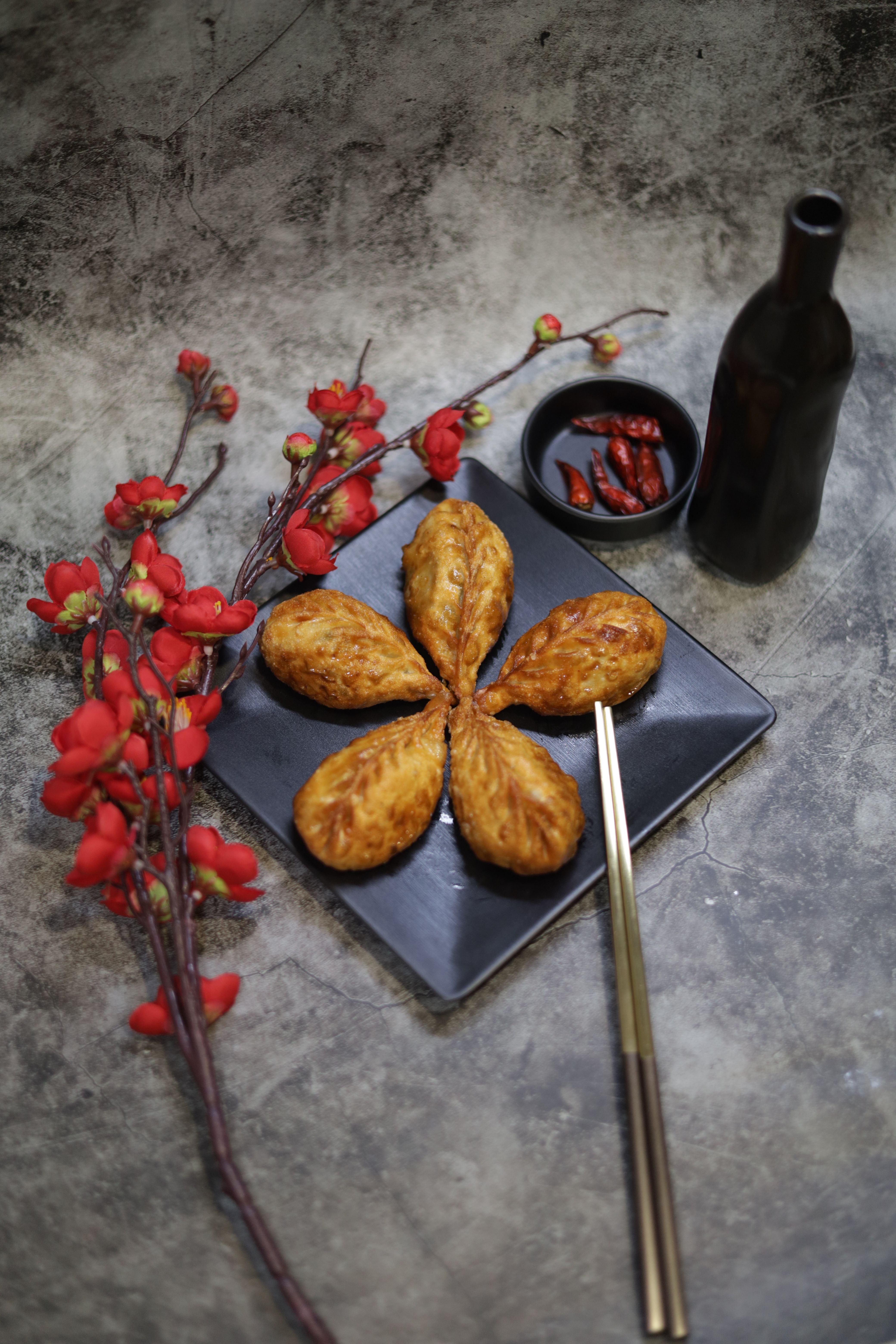 Elegant Food Presentation with Dumplings and Flowers · Free Stock Photo