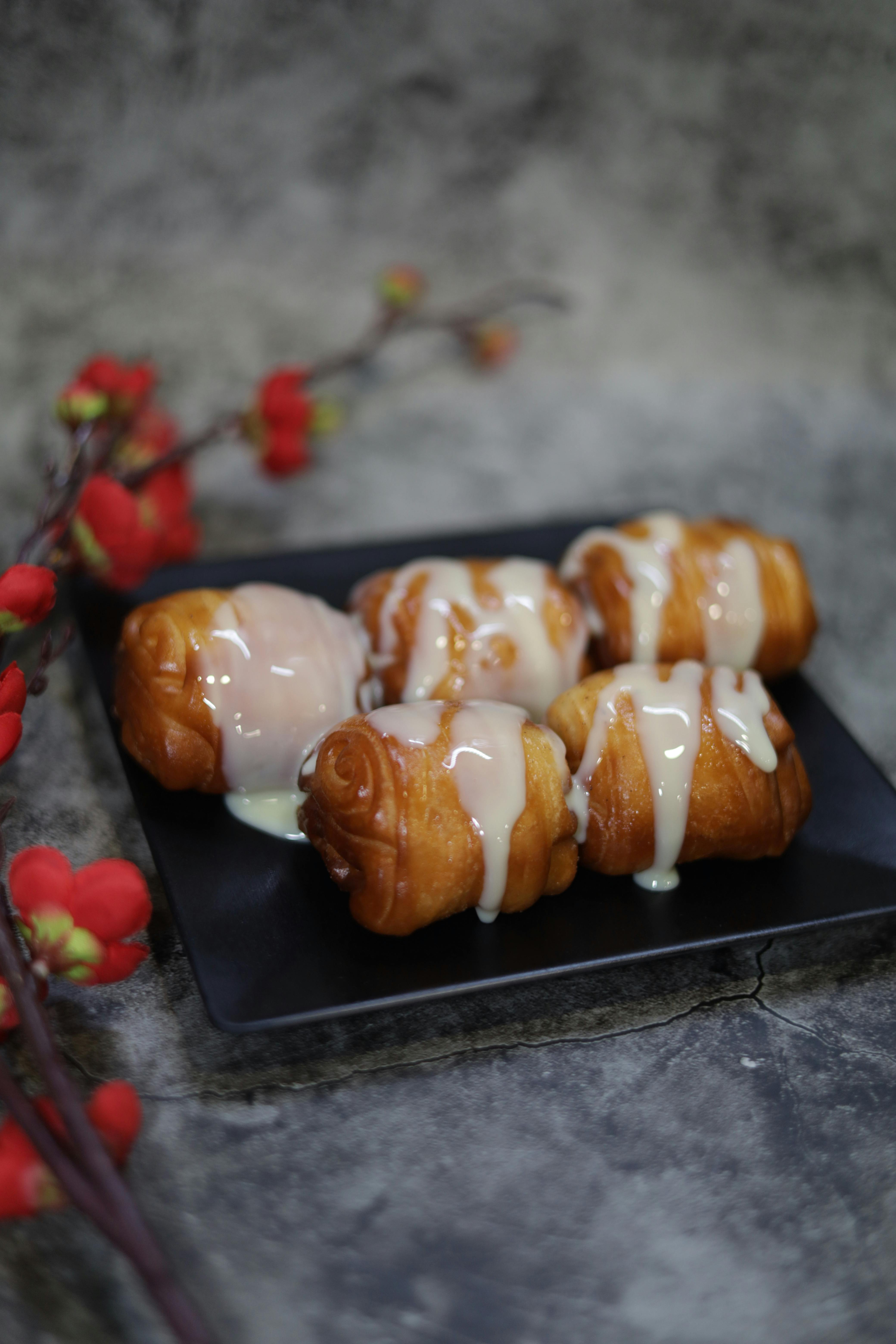 Close-up of Glazed Pastries on a Rustic Surface · Free Stock Photo