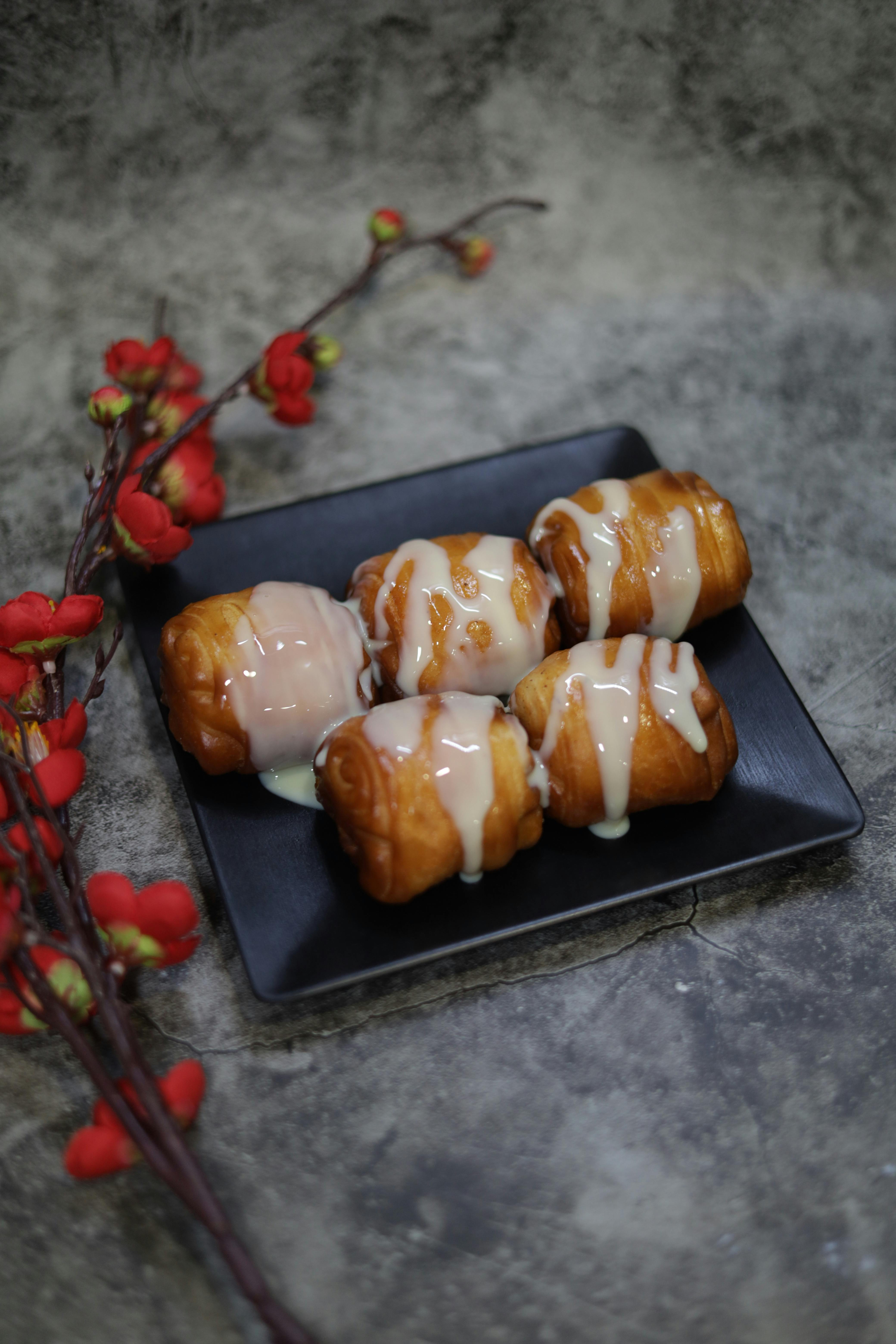 Delicious Glazed Pastries on Black Plate · Free Stock Photo