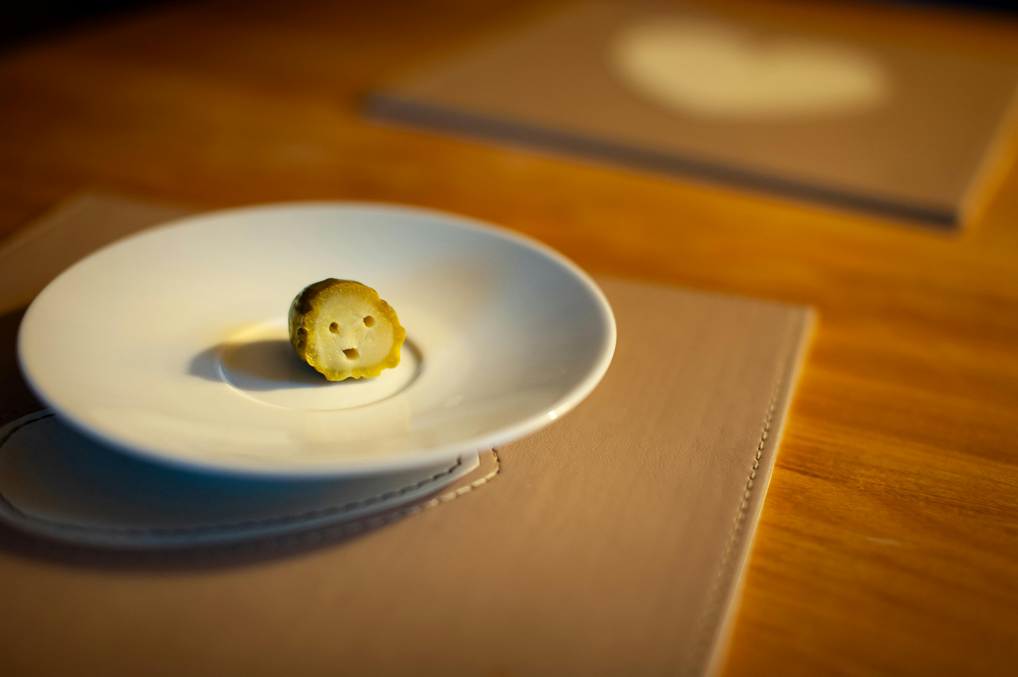 Smiling Gherkin Slice on a White Plate · Free Stock Photo