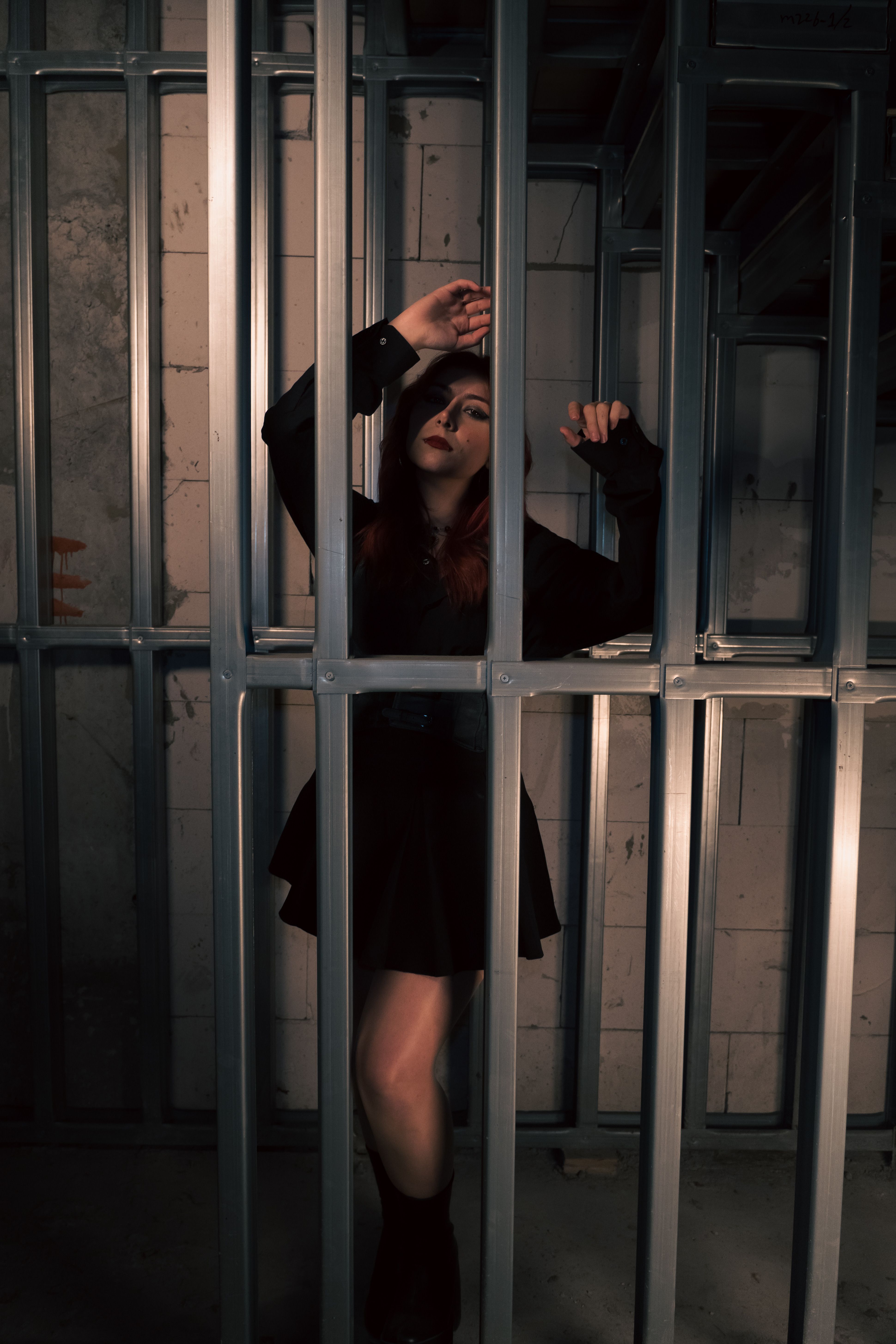 Moody Portrait of a Woman Behind Bars · Free Stock Photo