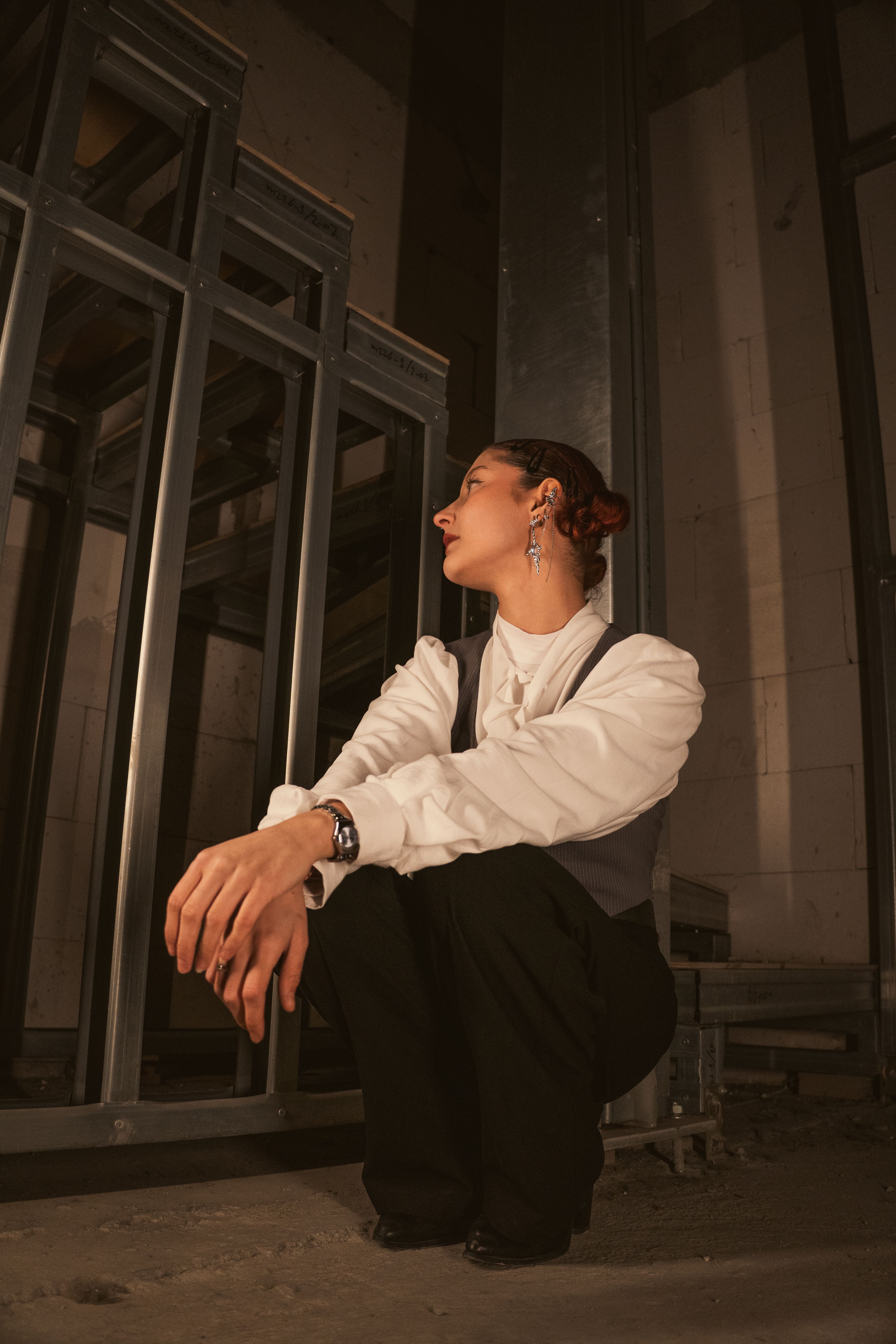 Reflective Woman in Industrial Setting Indoors · Free Stock Photo