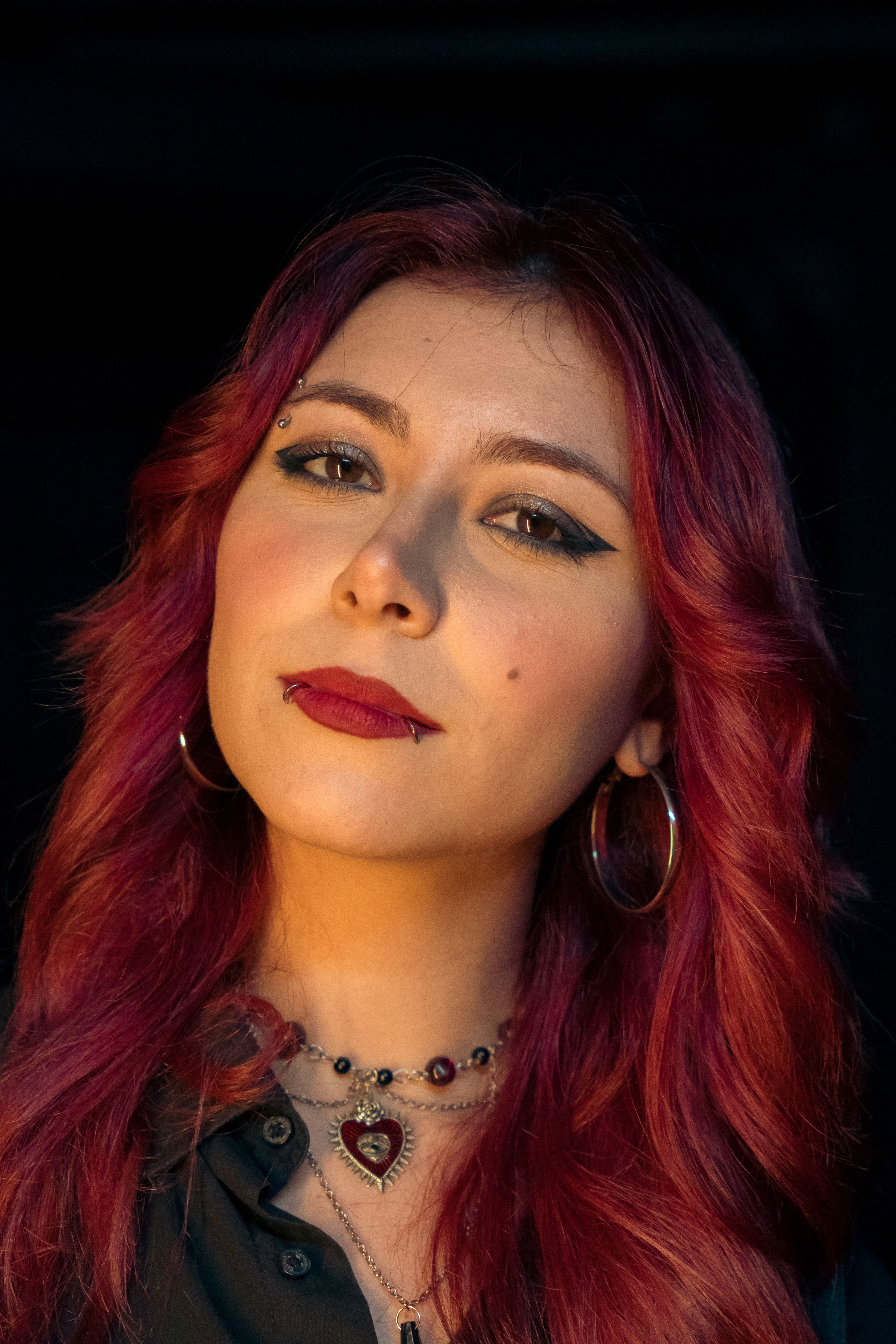 Portrait of a Woman with Red Hair and Piercings · Free Stock Photo