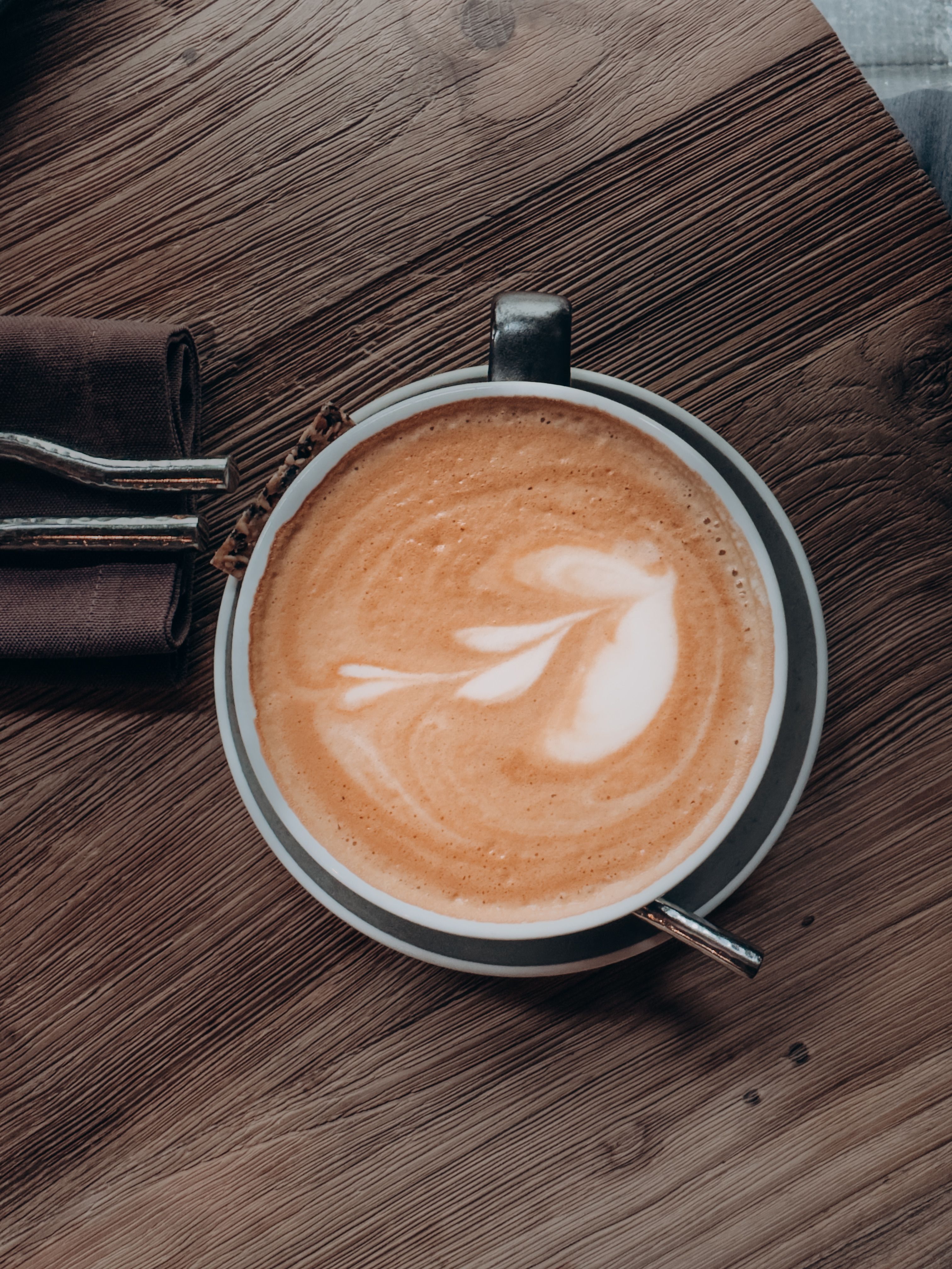 Top view of artisan latte with latte art on table · Free Stock Photo