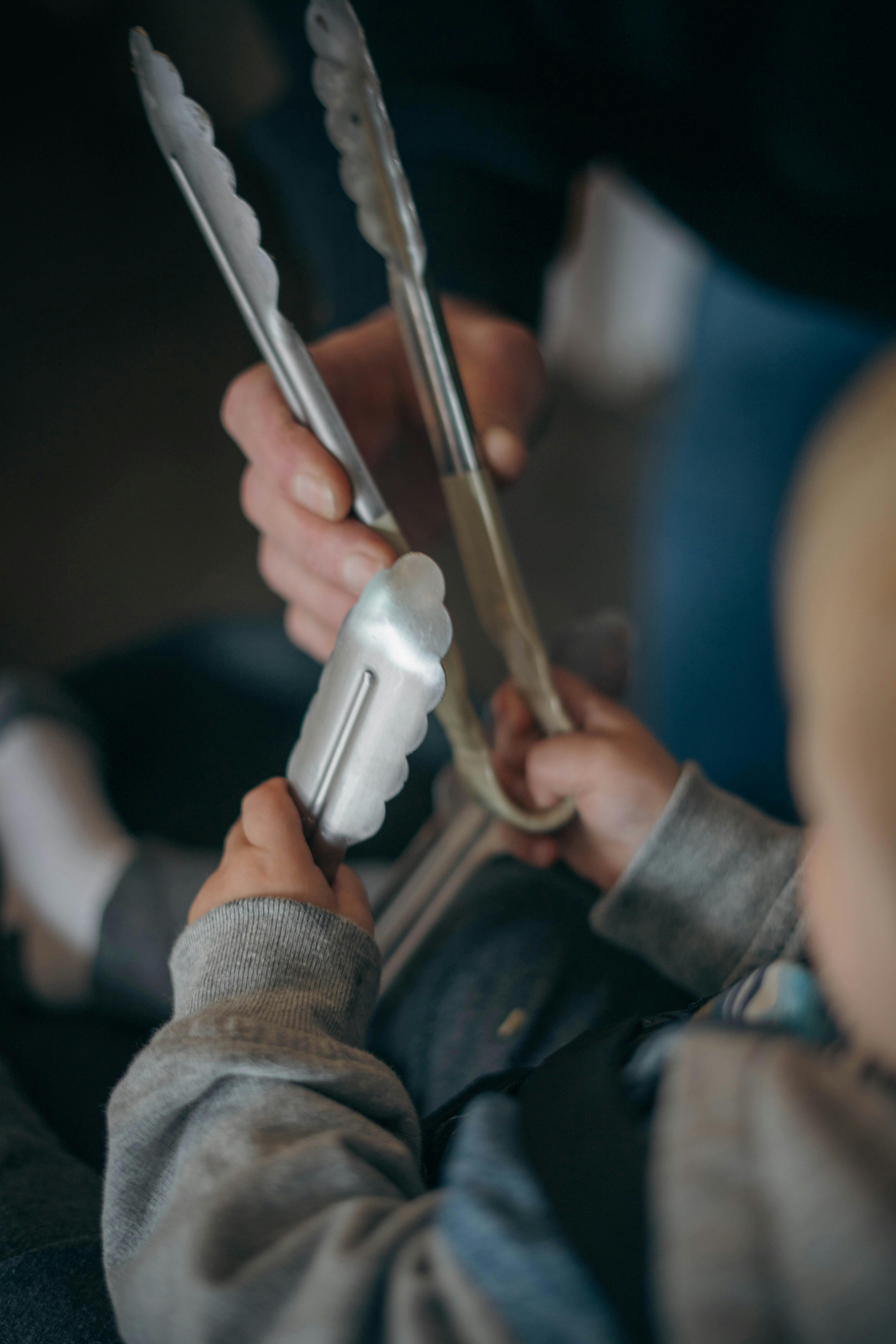 Child and Adult Using Kitchen Tongs Together · Free Stock Photo