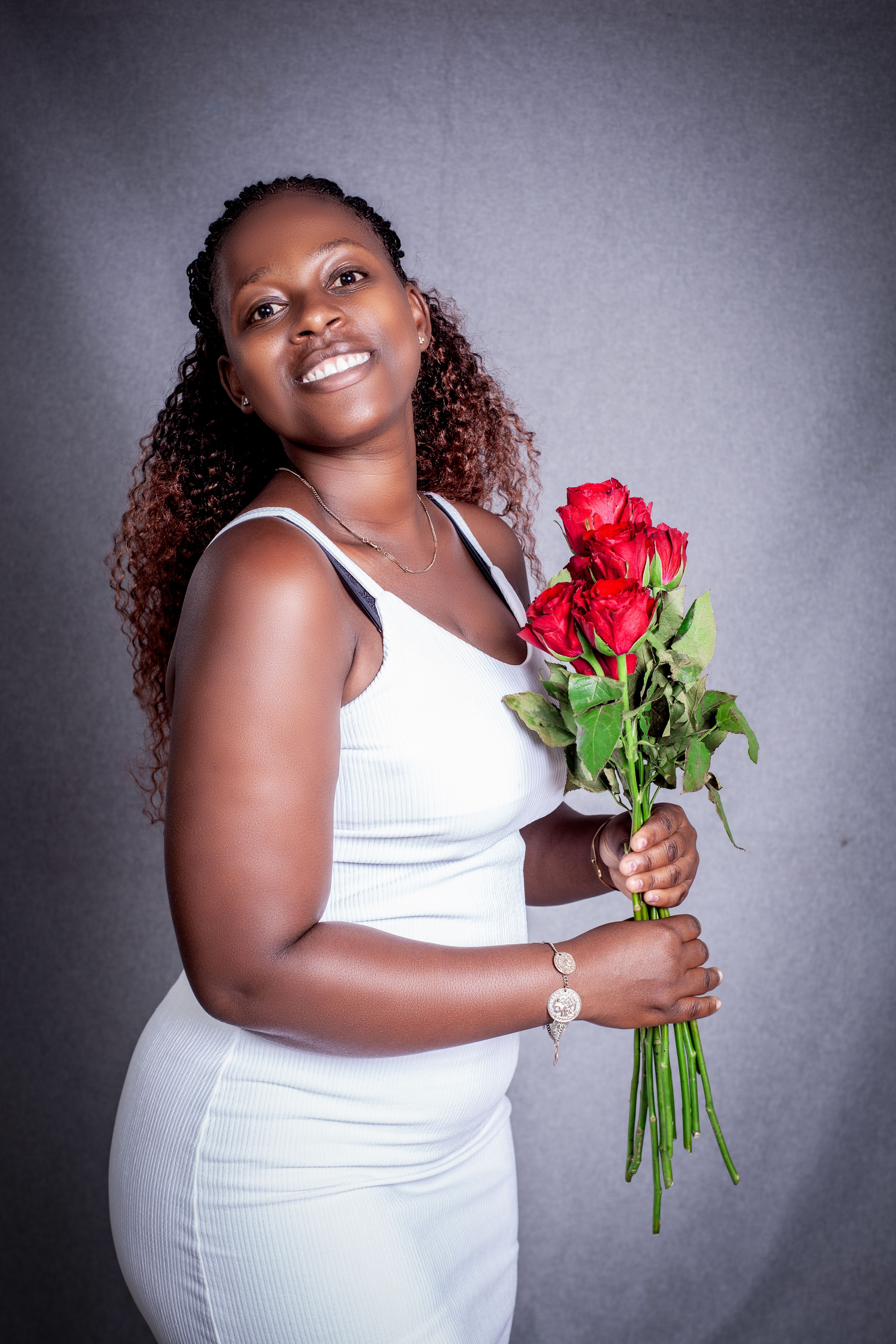 Smiling Woman Holding Red Roses in White Dress · Free Stock Photo