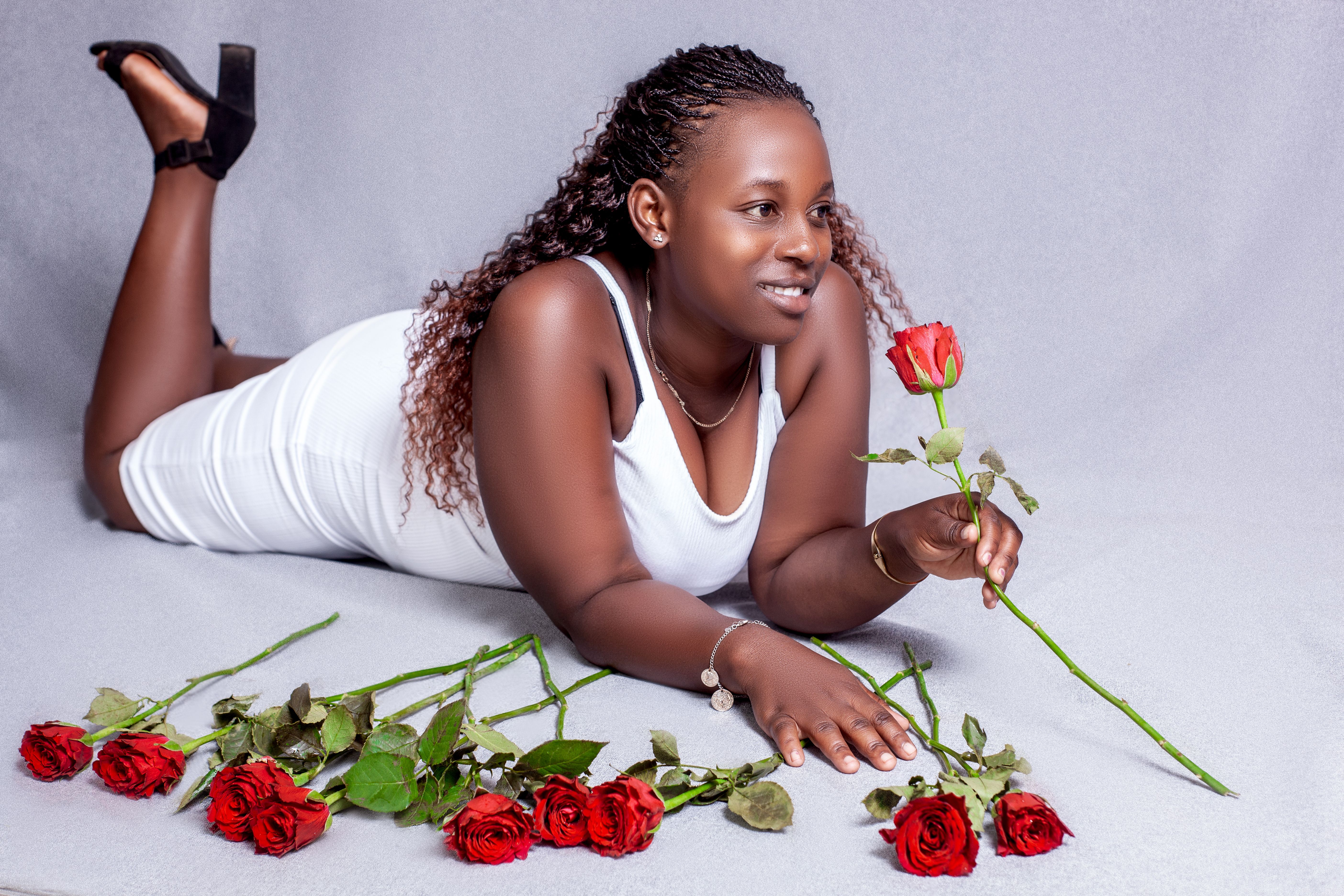 Elegant Black Woman with Roses in Studio Setting · Free Stock Photo