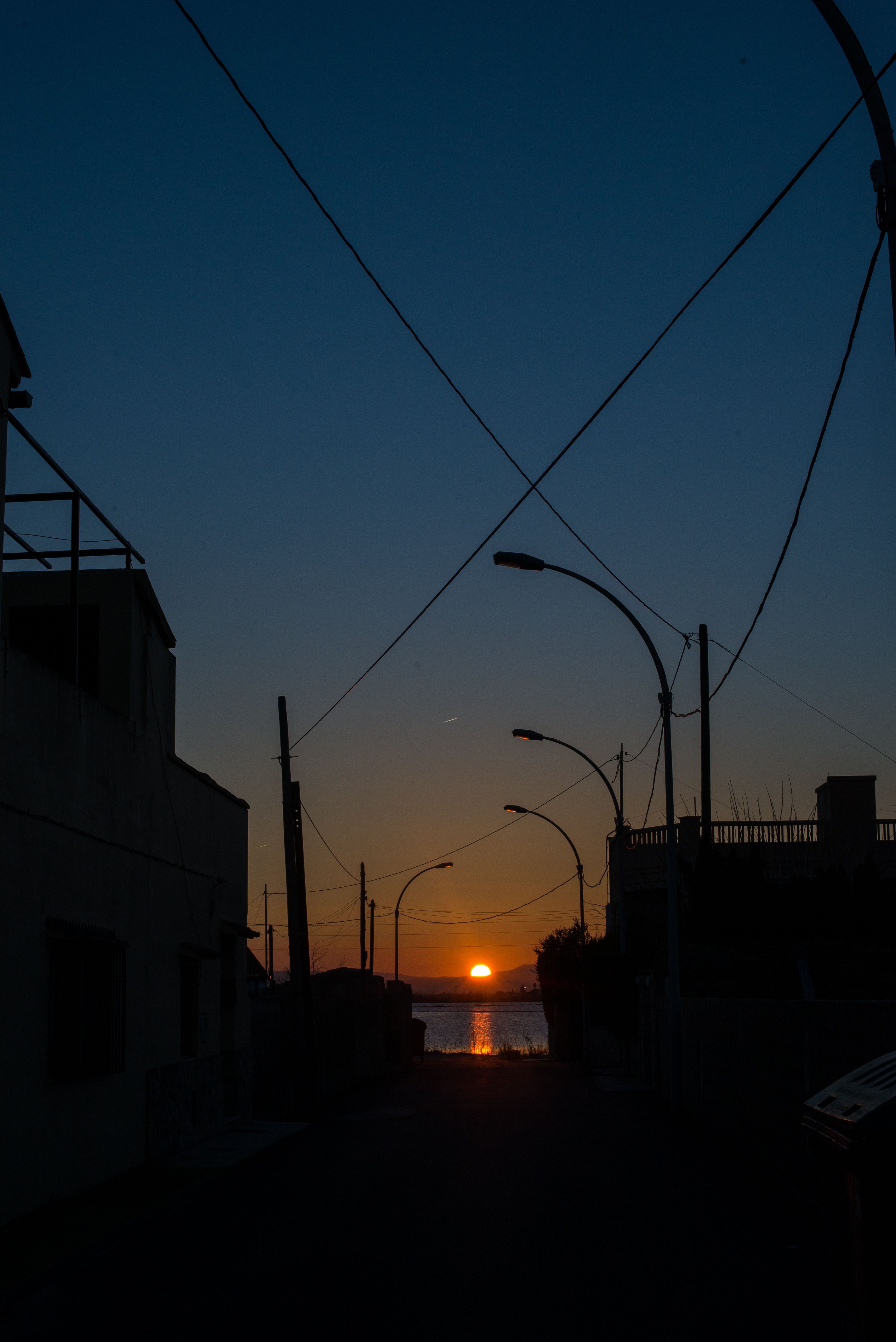 Scenic Street Sunset Silhouette with Ocean View · Free Stock Photo