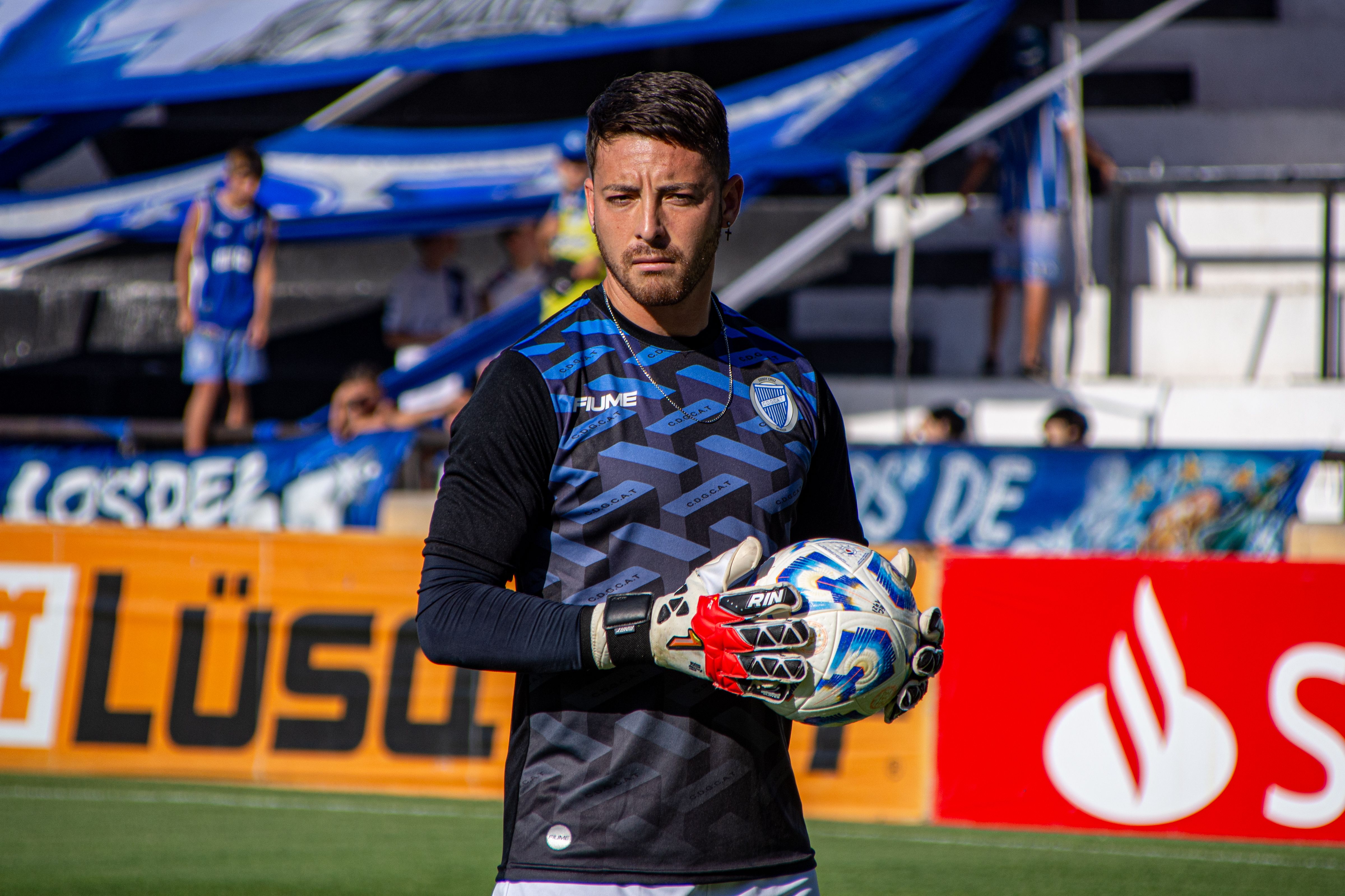Soccer Goalkeeper Holding Ball on Field · Free Stock Photo