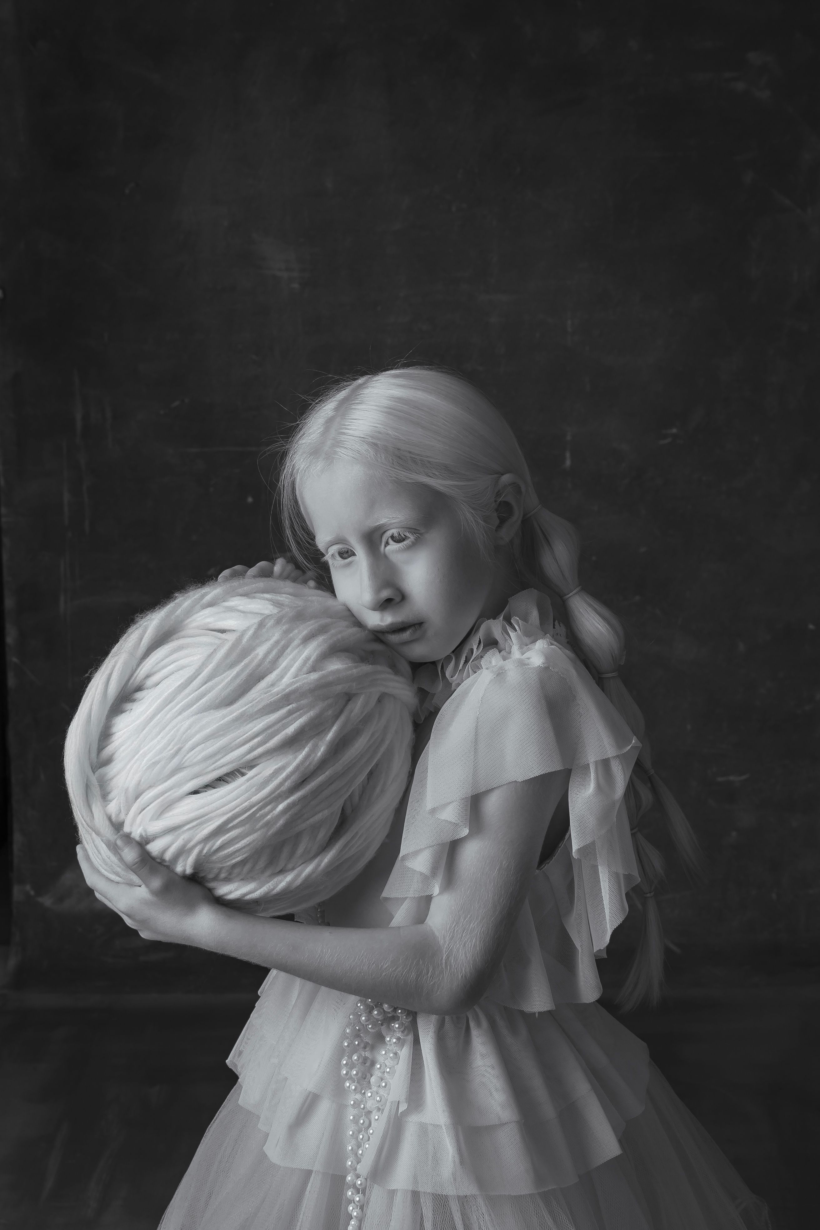 Ethereal Portrait of Child with Yarn Ball · Free Stock Photo