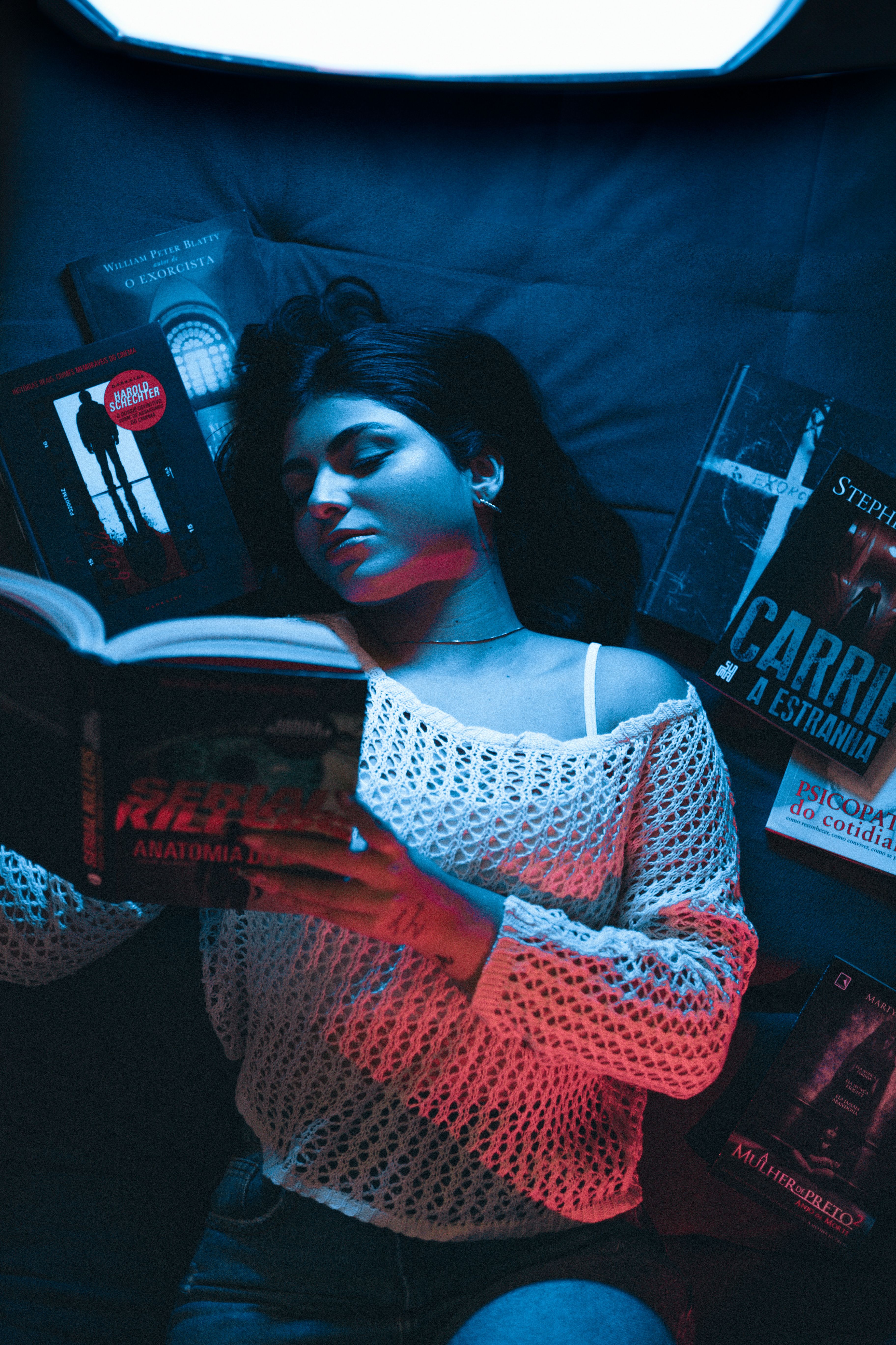 Relaxed Woman Reading Surrounded by Books · Free Stock Photo