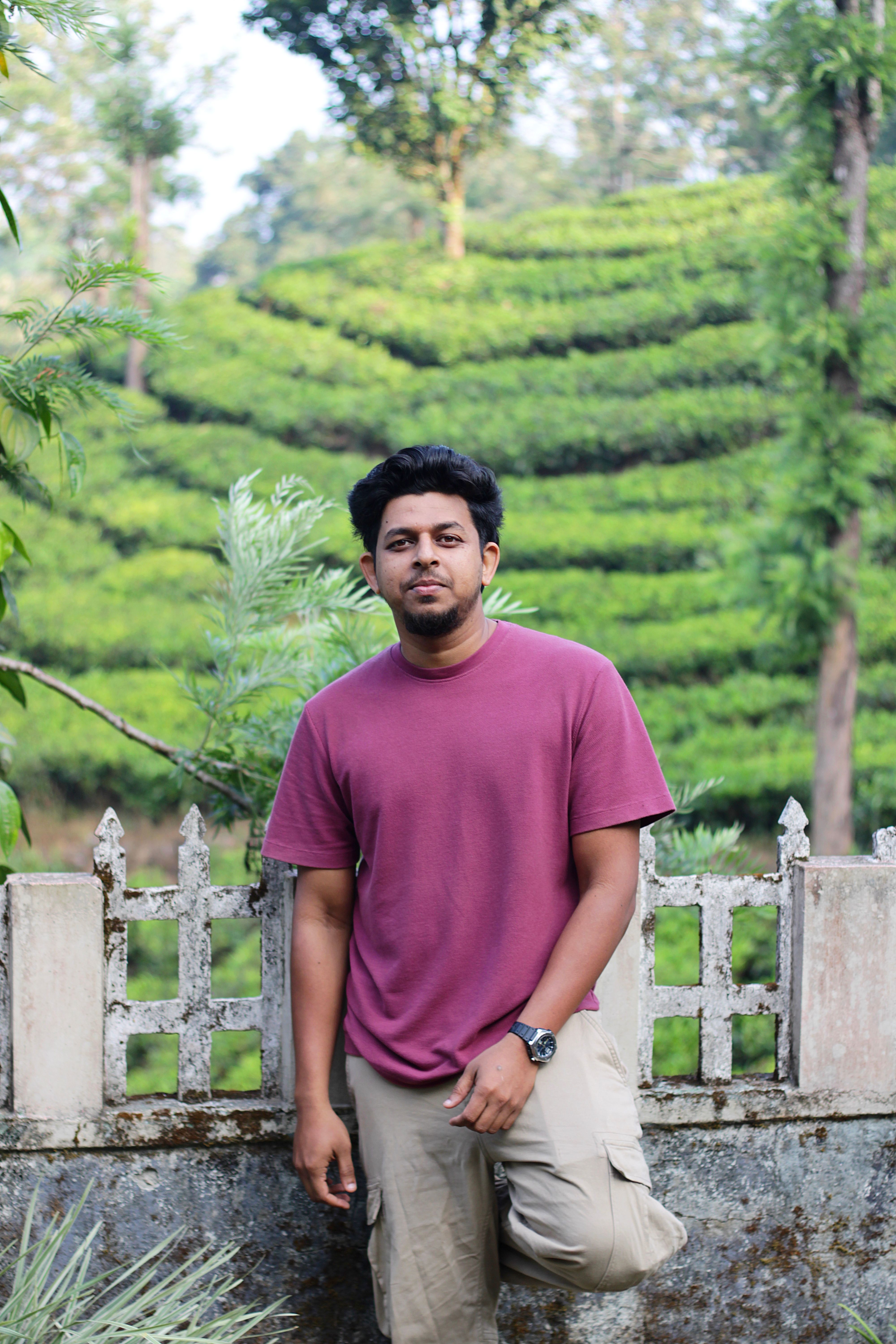 Man Posing in Lush Green Tea Plantation · Free Stock Photo