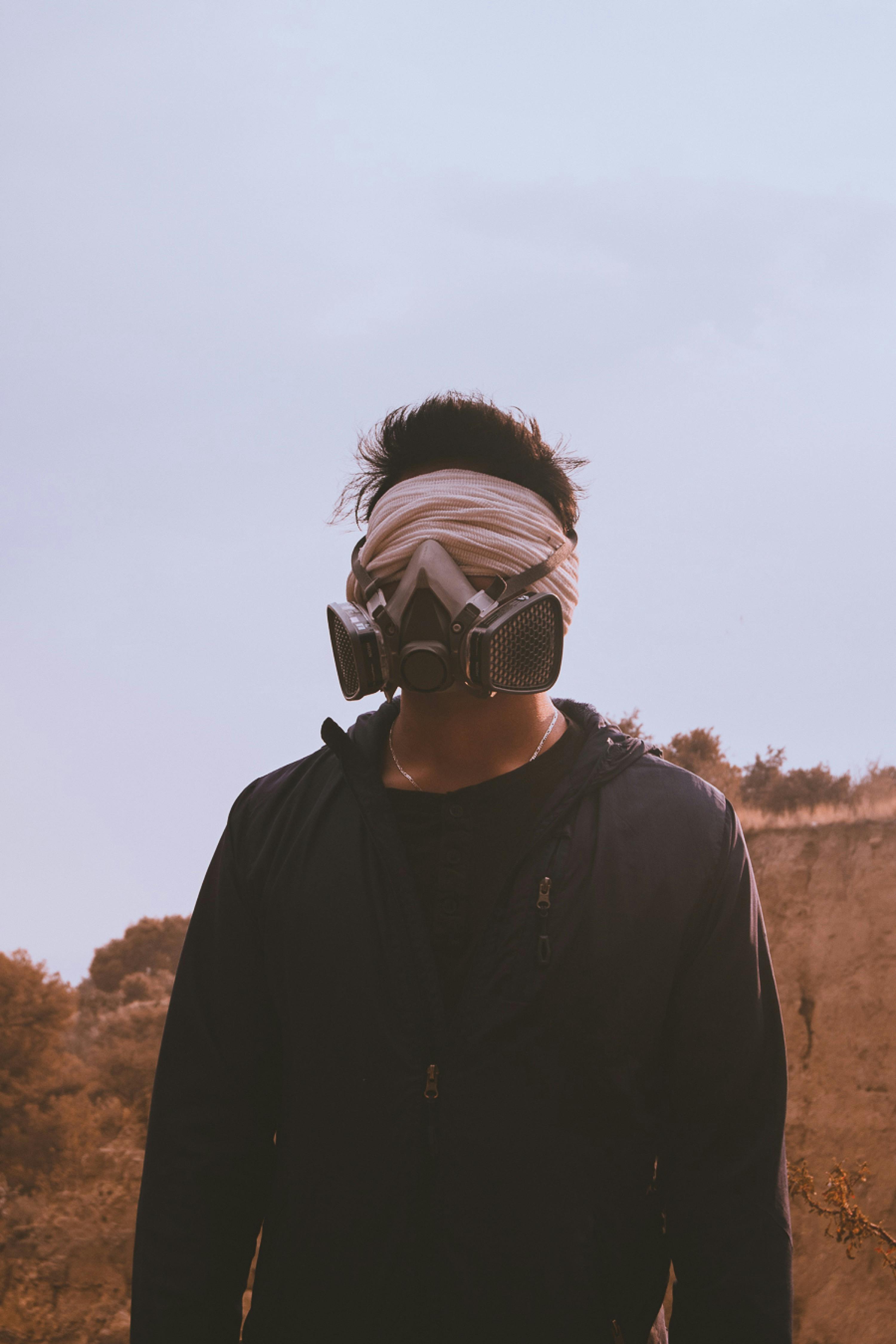 Person with Gas Mask in Outdoor Setting · Free Stock Photo