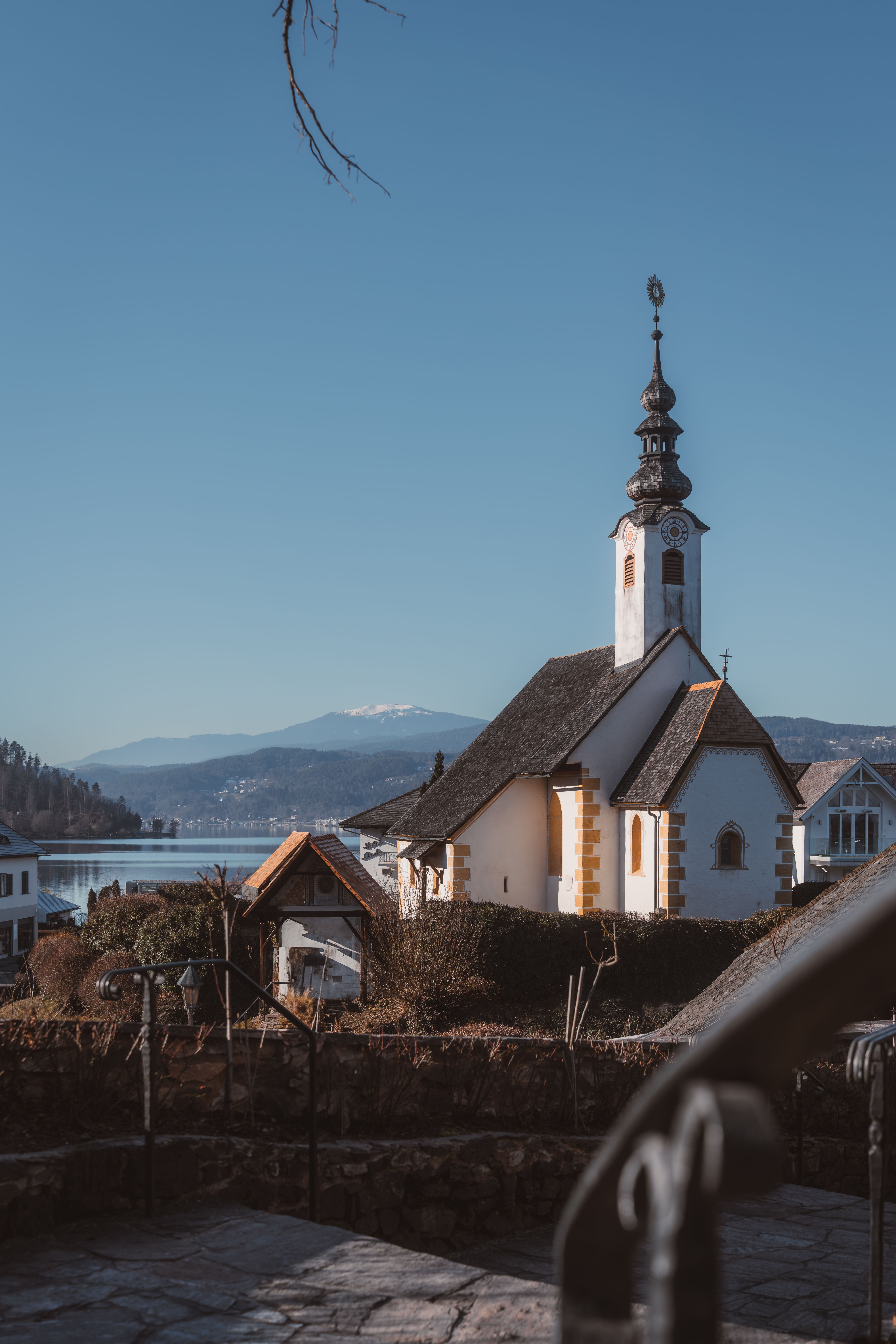Charming Alpine Church with Mountainous Backdrop · Free Stock Photo