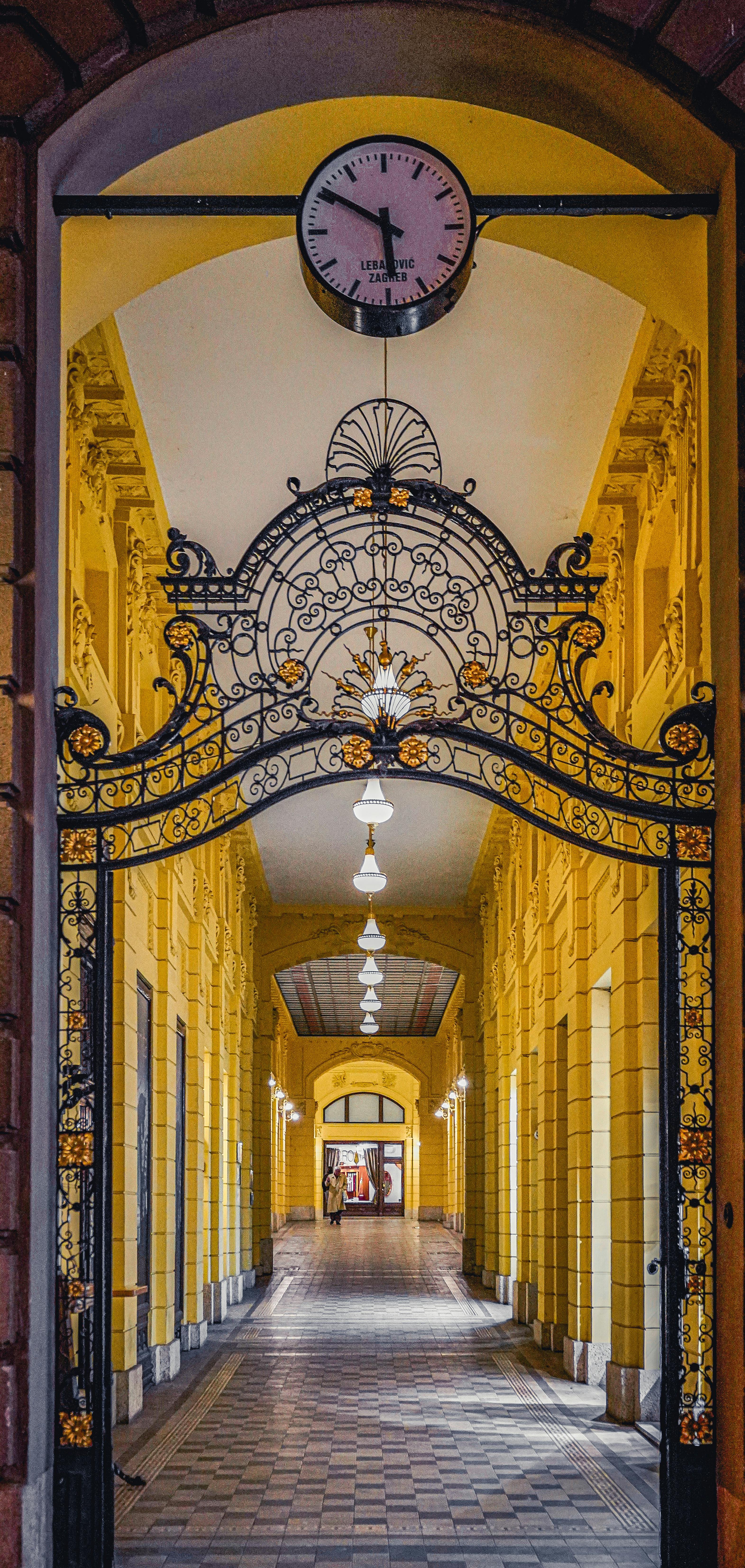 Elegant Historic European Corridor with Clock · Free Stock Photo