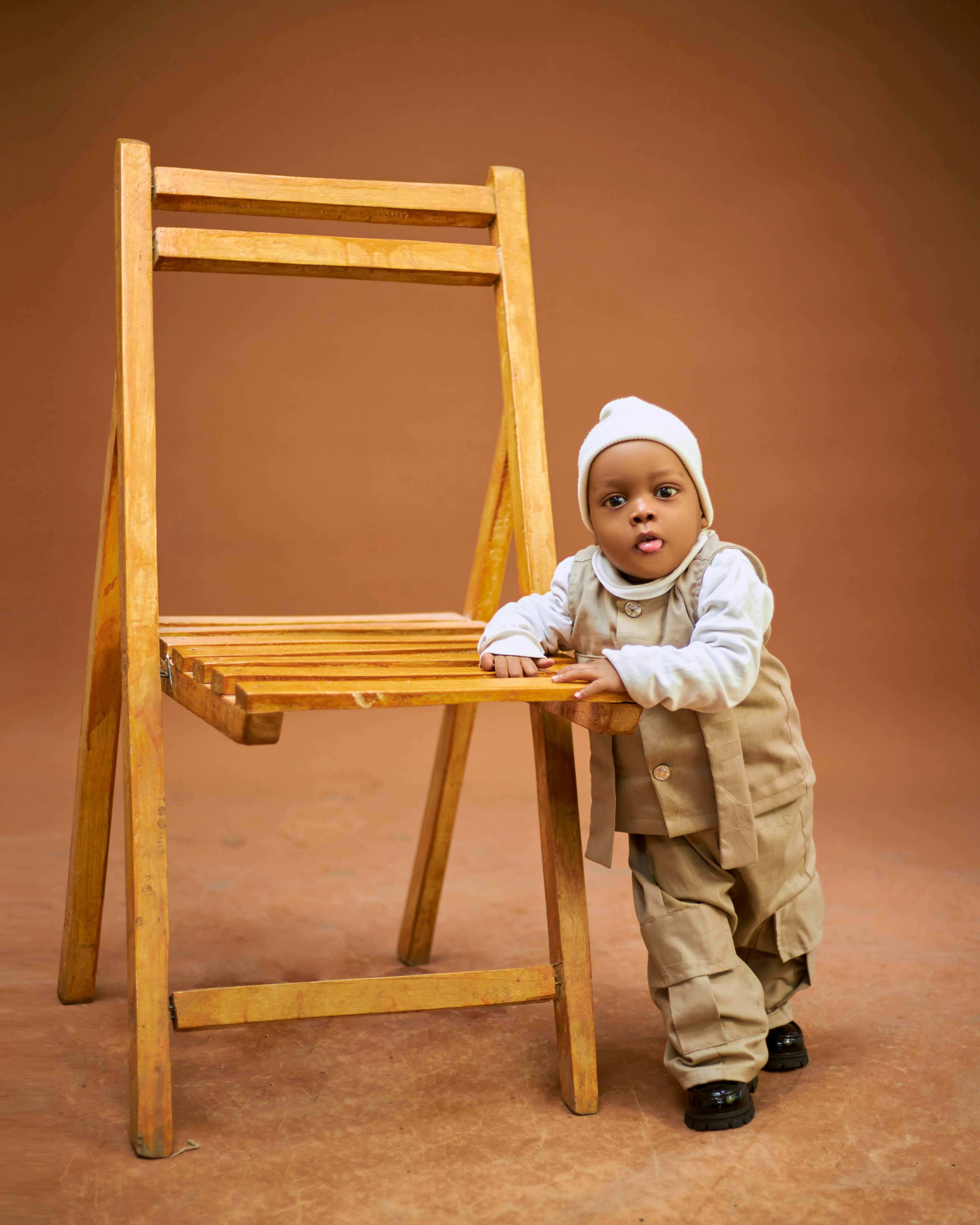Cute Baby Standing with Wooden Chair · Free Stock Photo