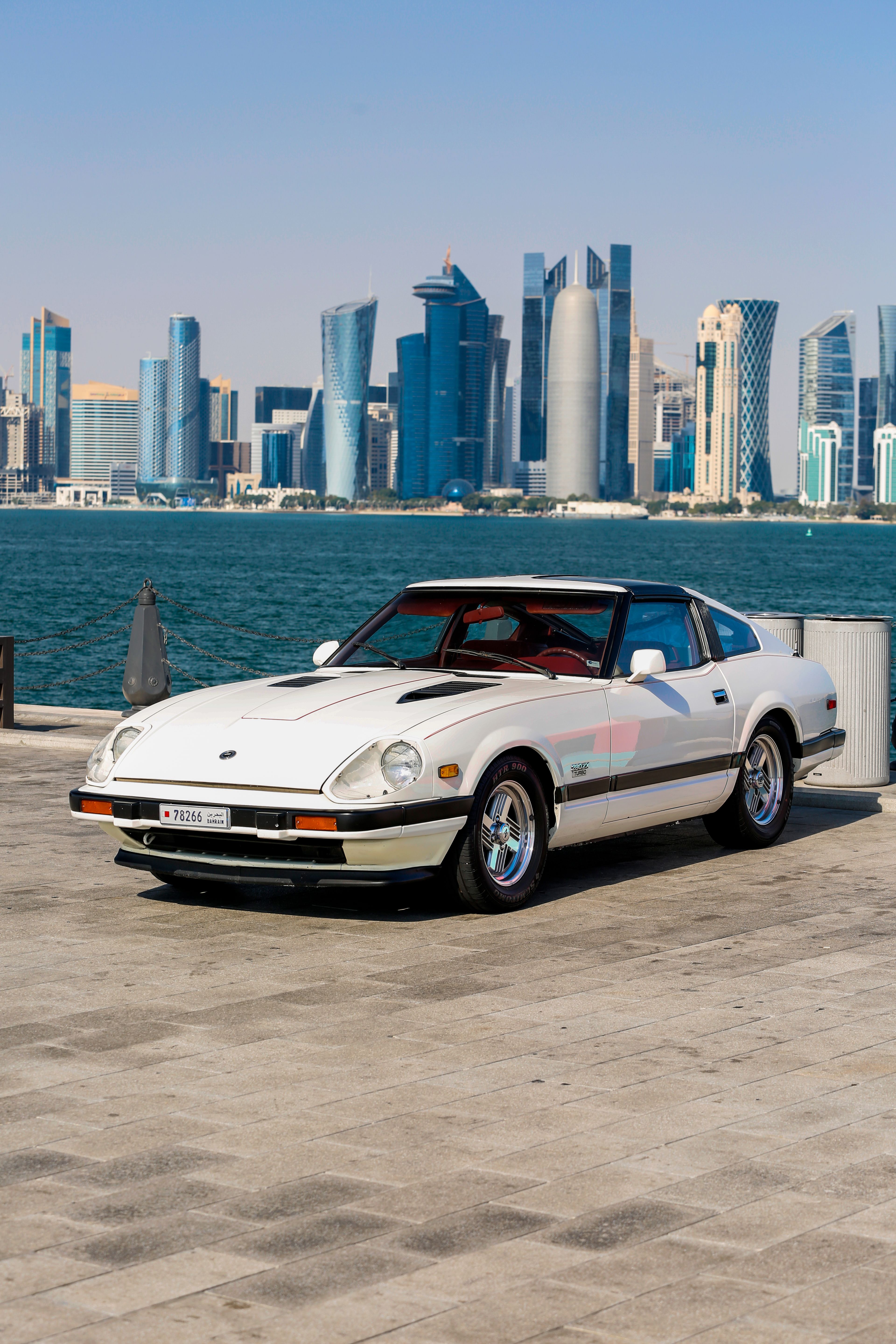 Classic Car with Doha Skyline in Background · Free Stock Photo