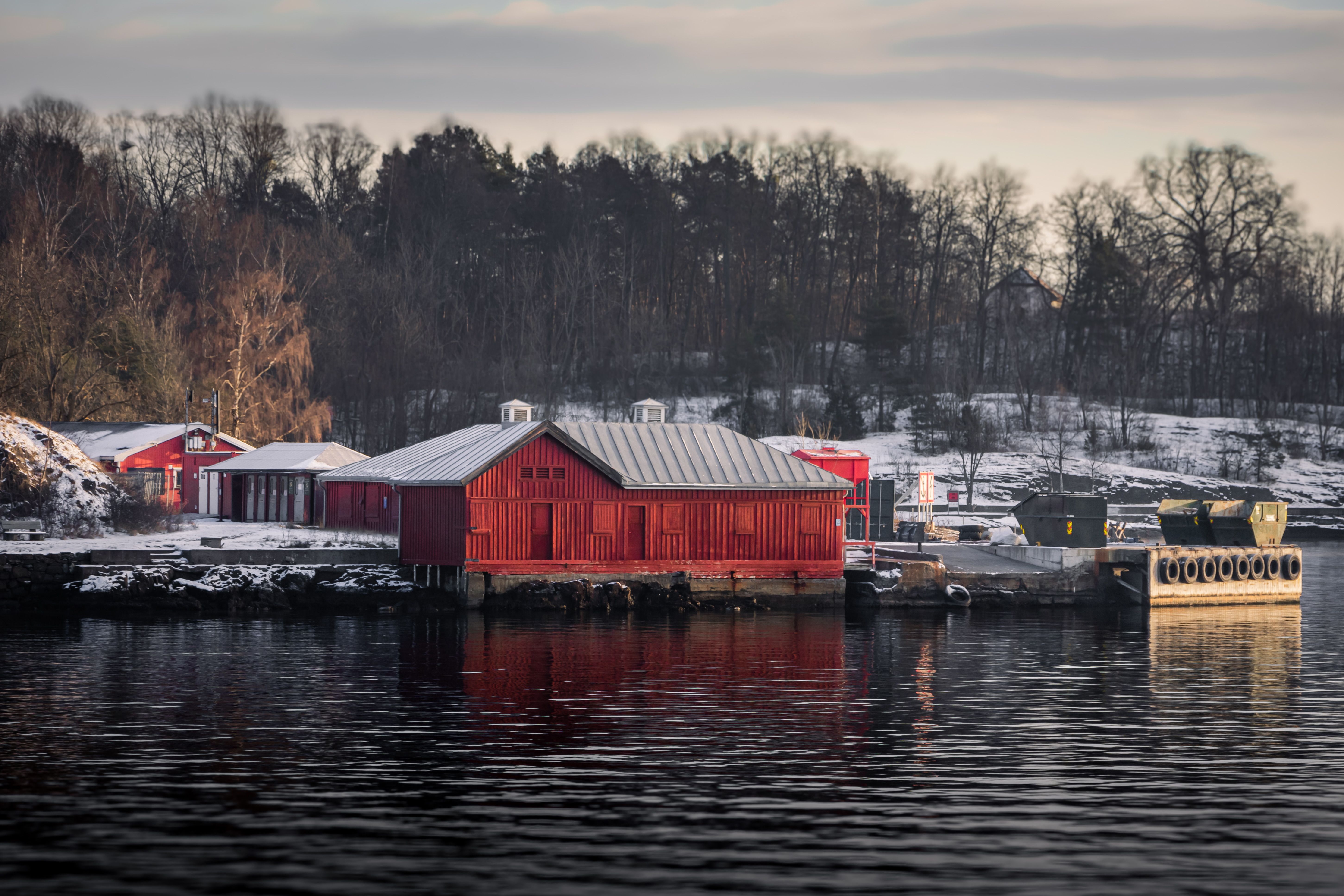Scenic Red Boathouse on Winter Waterfront · Free Stock Photo