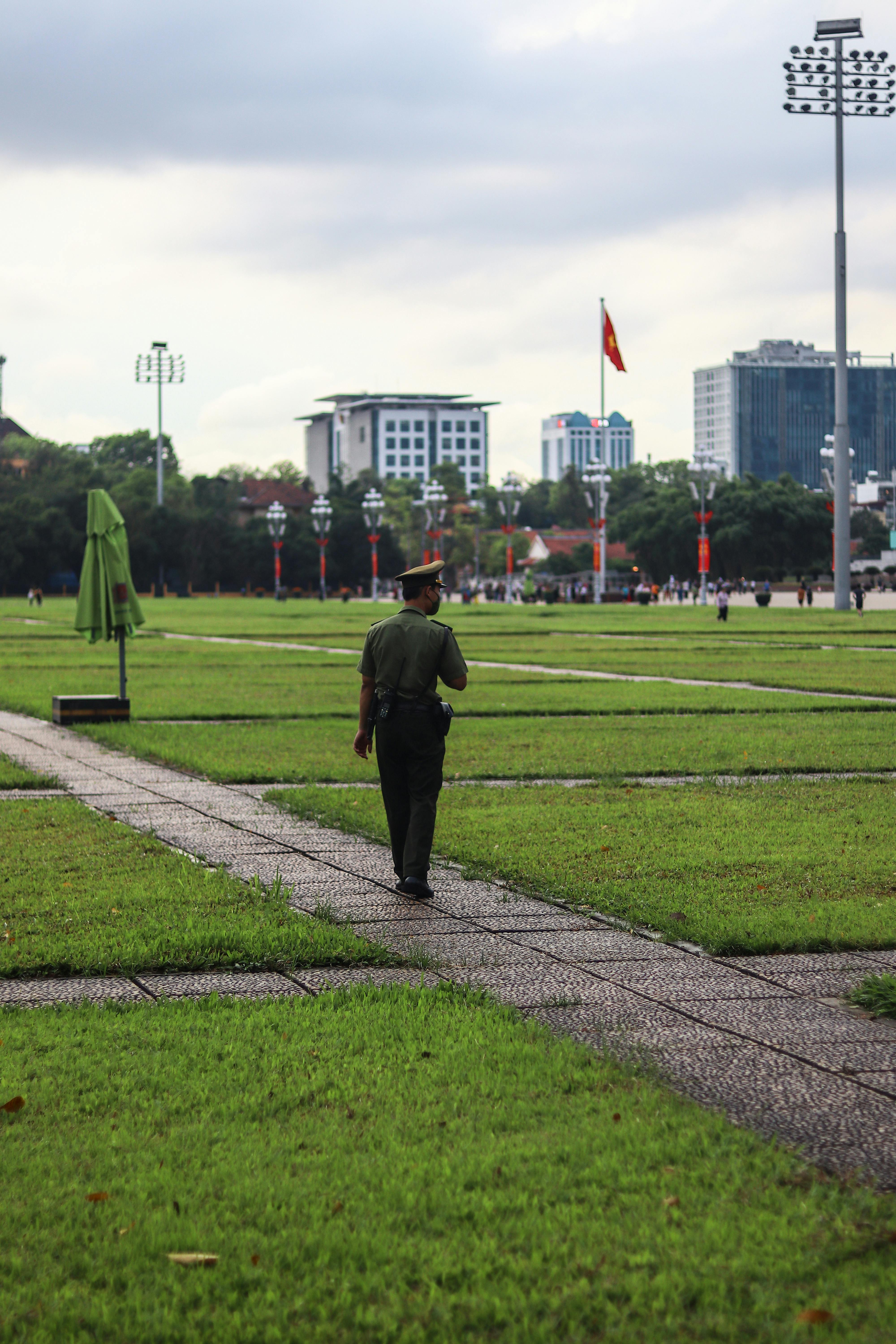 Security Guard Patrolling Urban Park · Free Stock Photo
