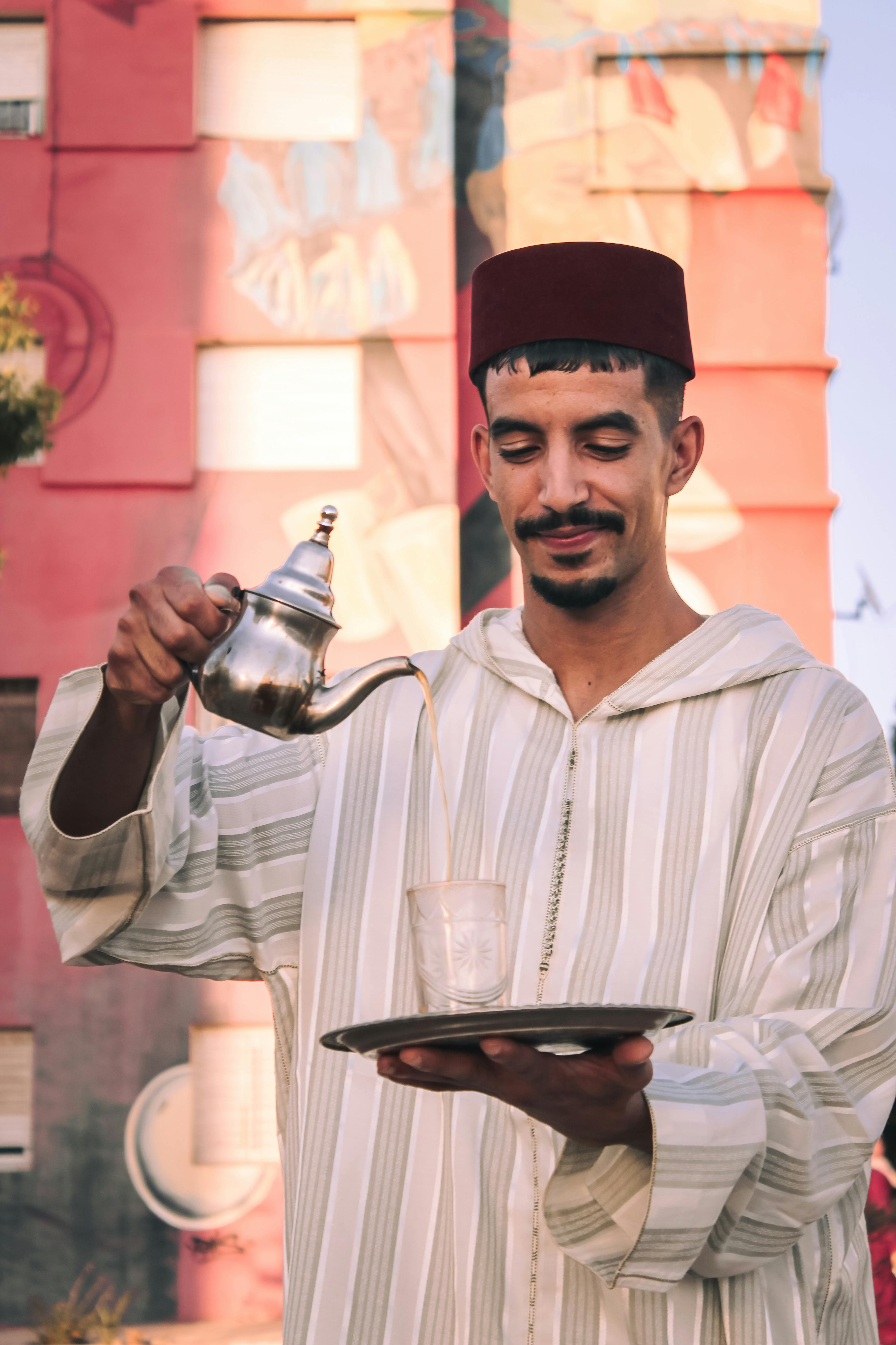 Traditional Moroccan Tea Pouring Ceremony Outdoors · Free Stock Photo