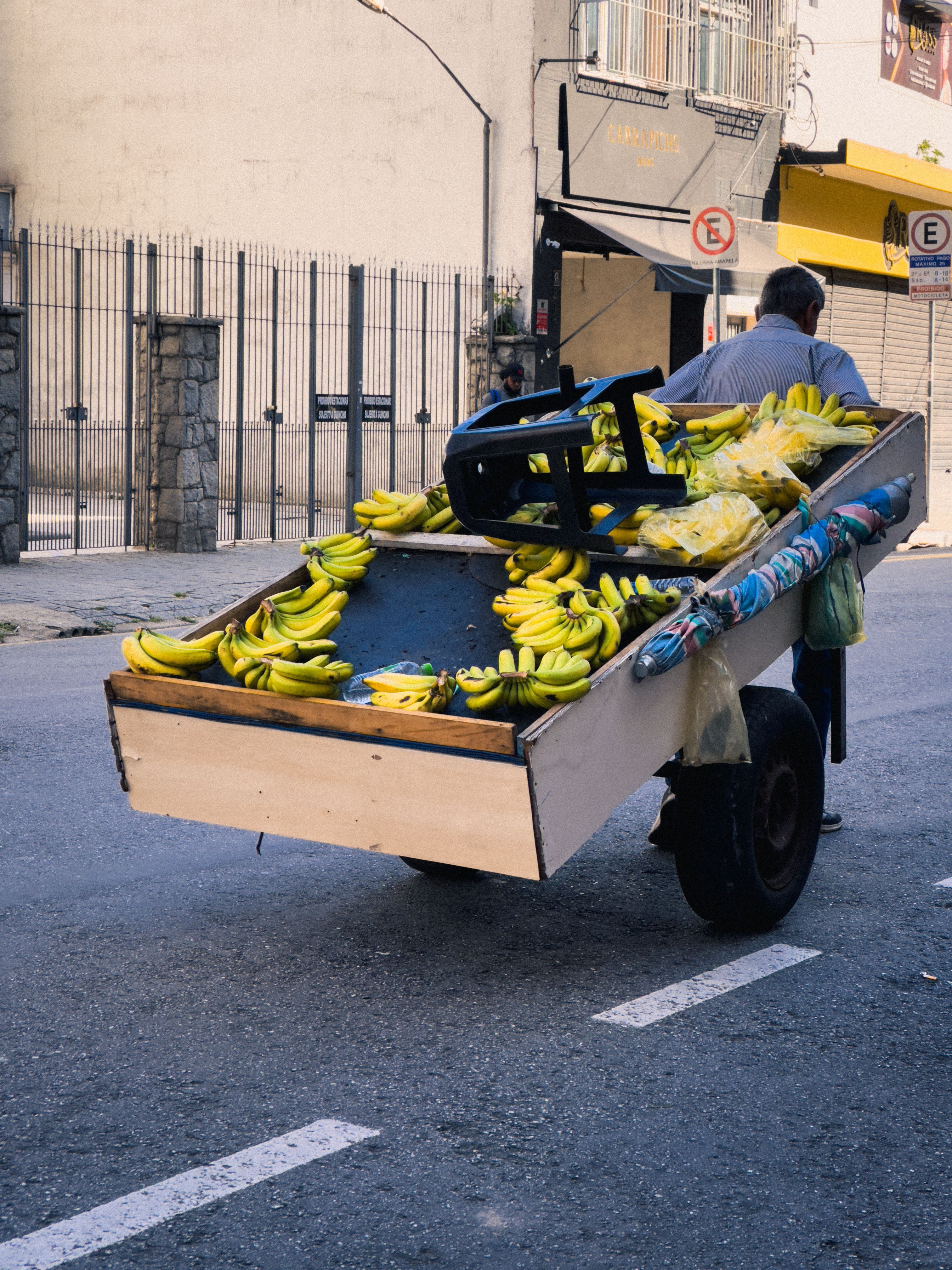 Street Vendor with Cart of Fresh Bananas · Free Stock Photo