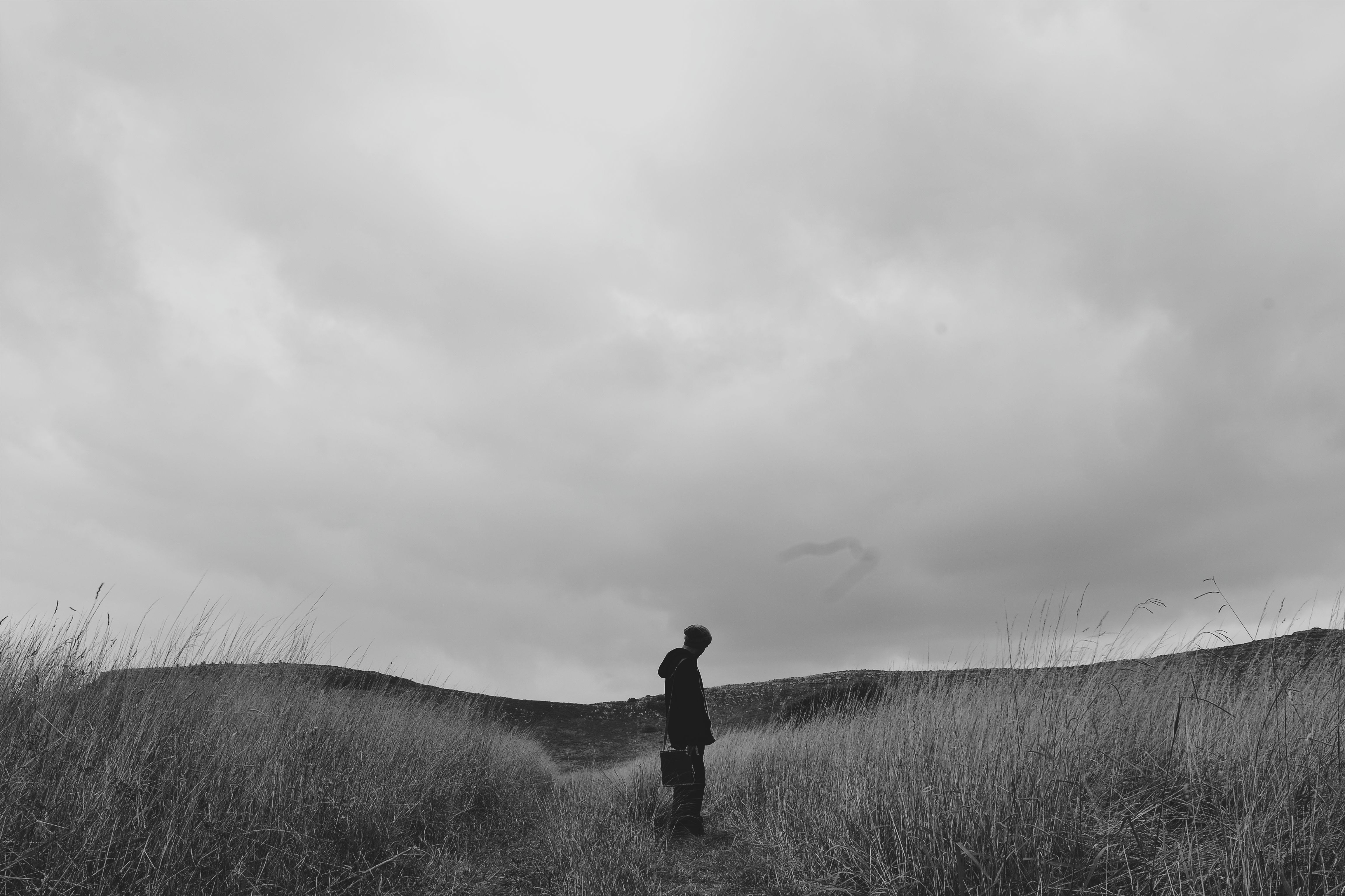 Lonely figure in a desolate landscape · Free Stock Photo