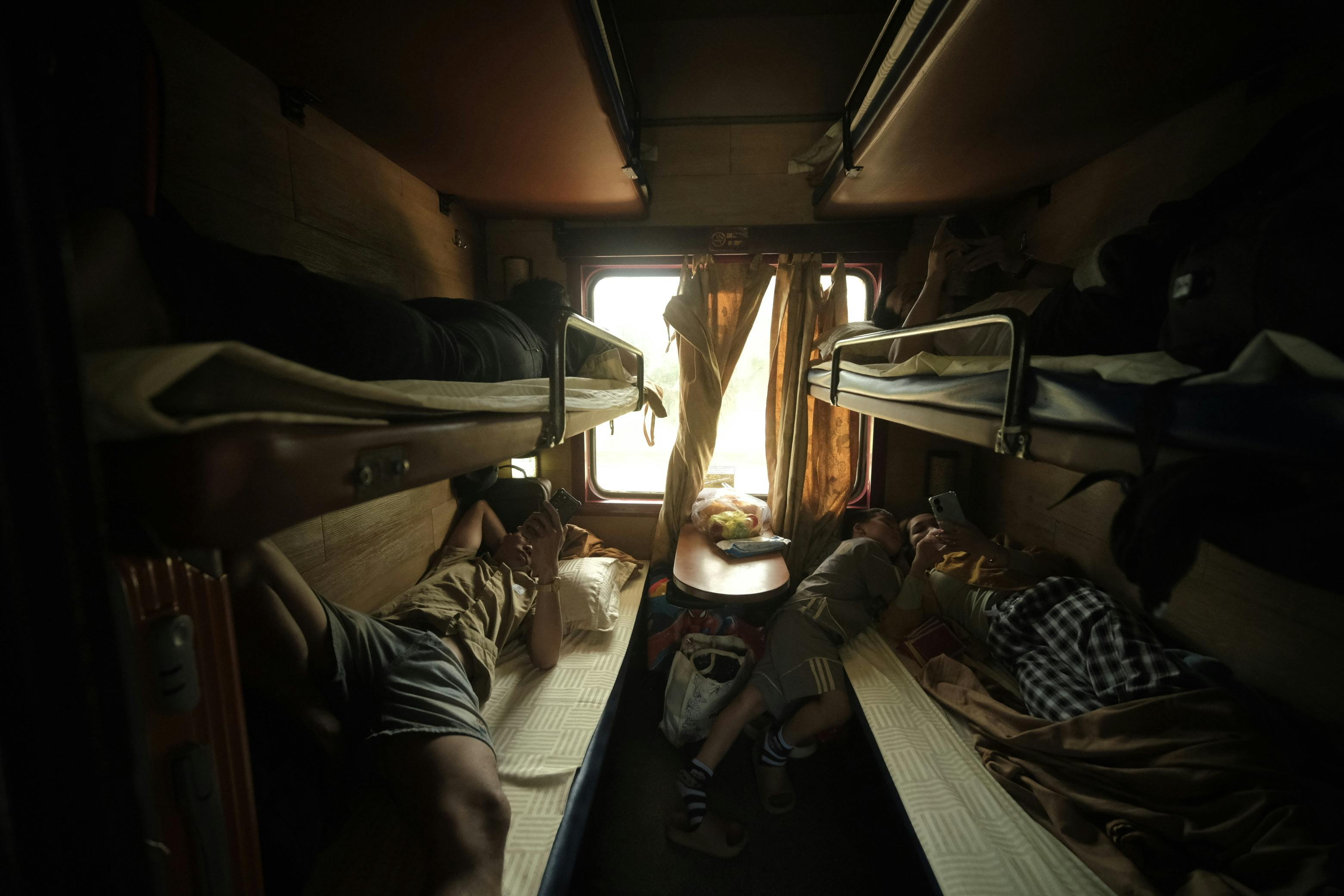 Cozy train cabin with passengers relaxing · Free Stock Photo