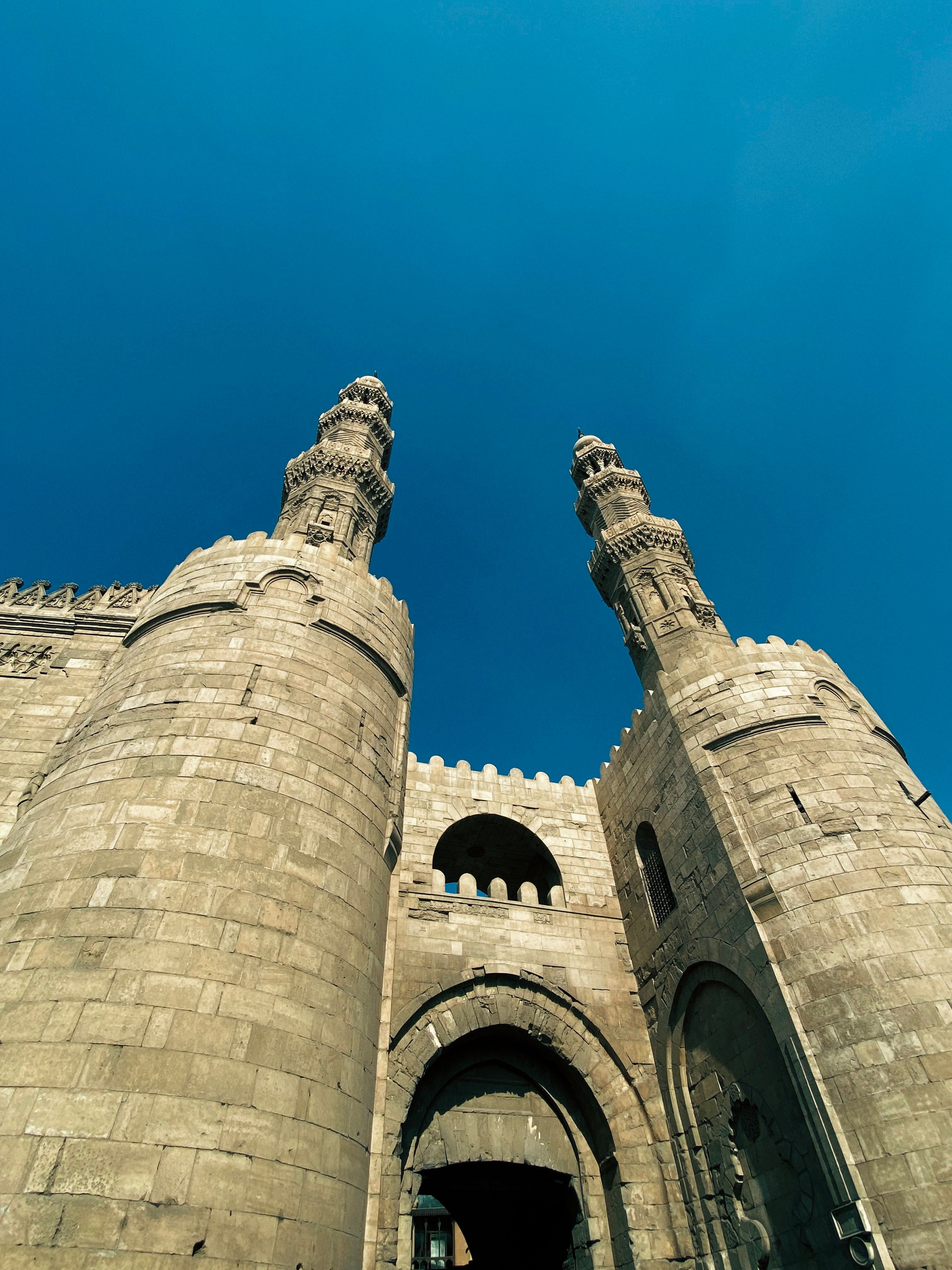 Historic Mosque with Twin Minarets Against Blue Sky · Free Stock Photo