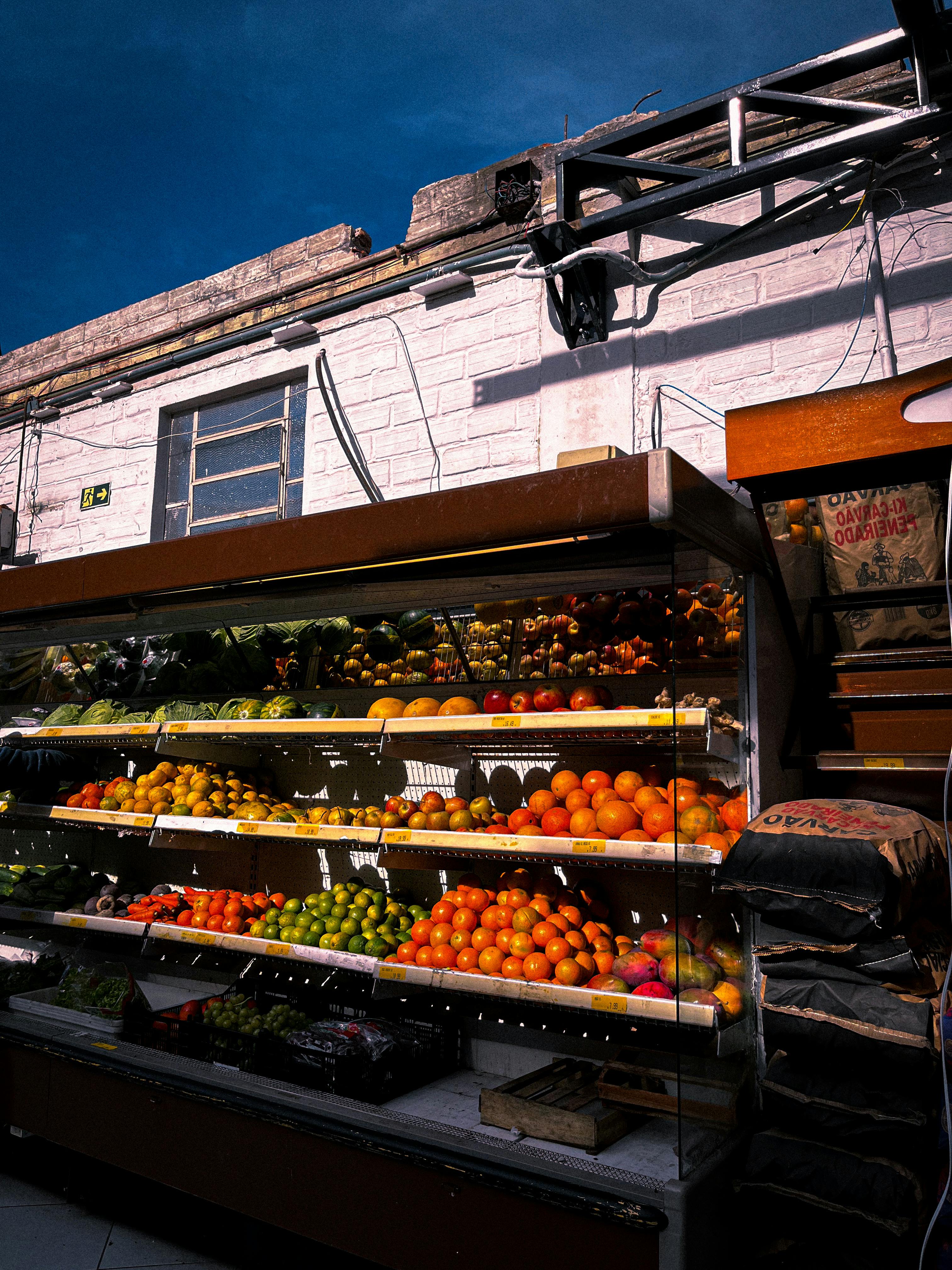 Vibrant Outdoor Fruit Stand in Sunlight · Free Stock Photo