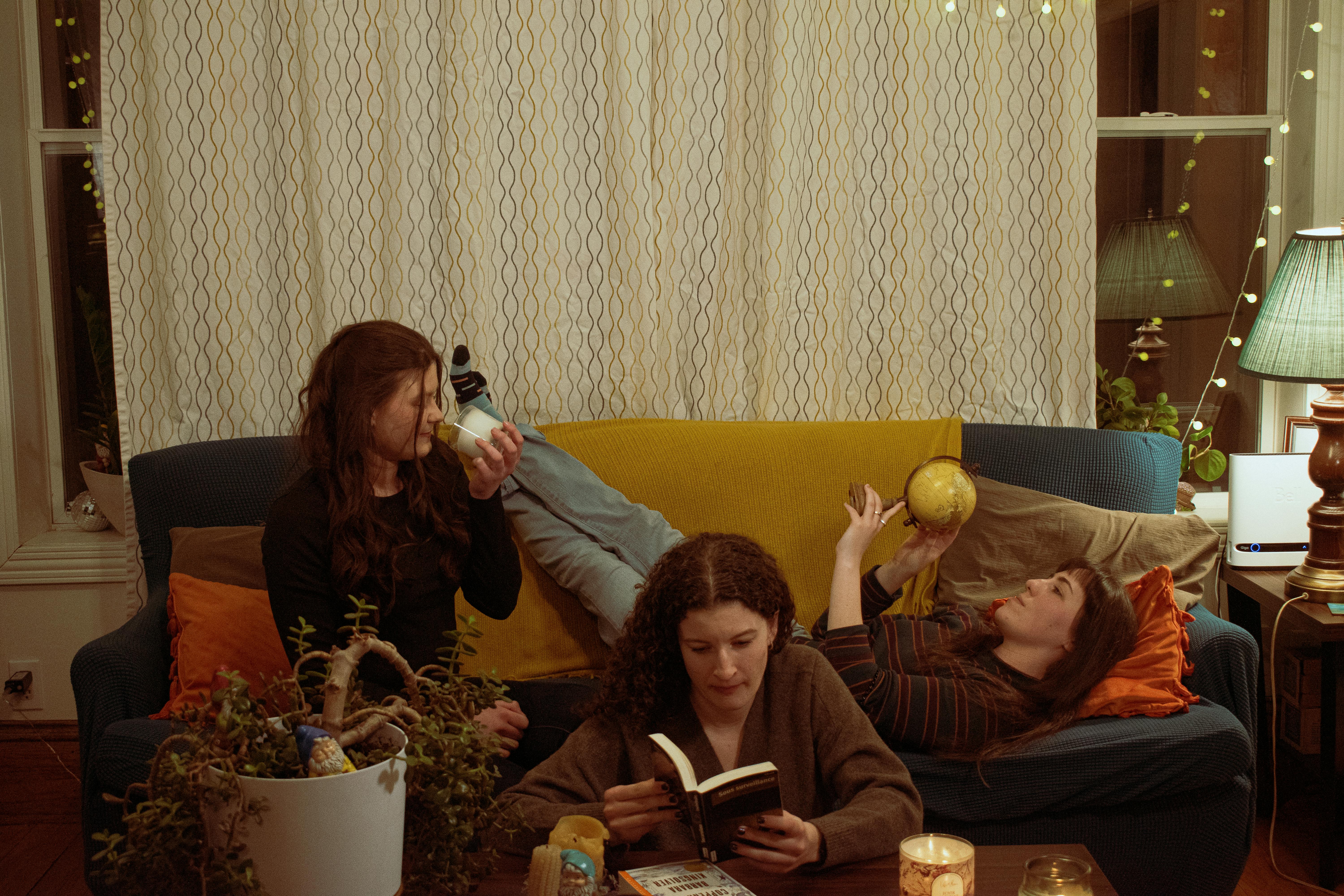 Cozy Indoor Gathering with Friends on a Couch · Free Stock Photo