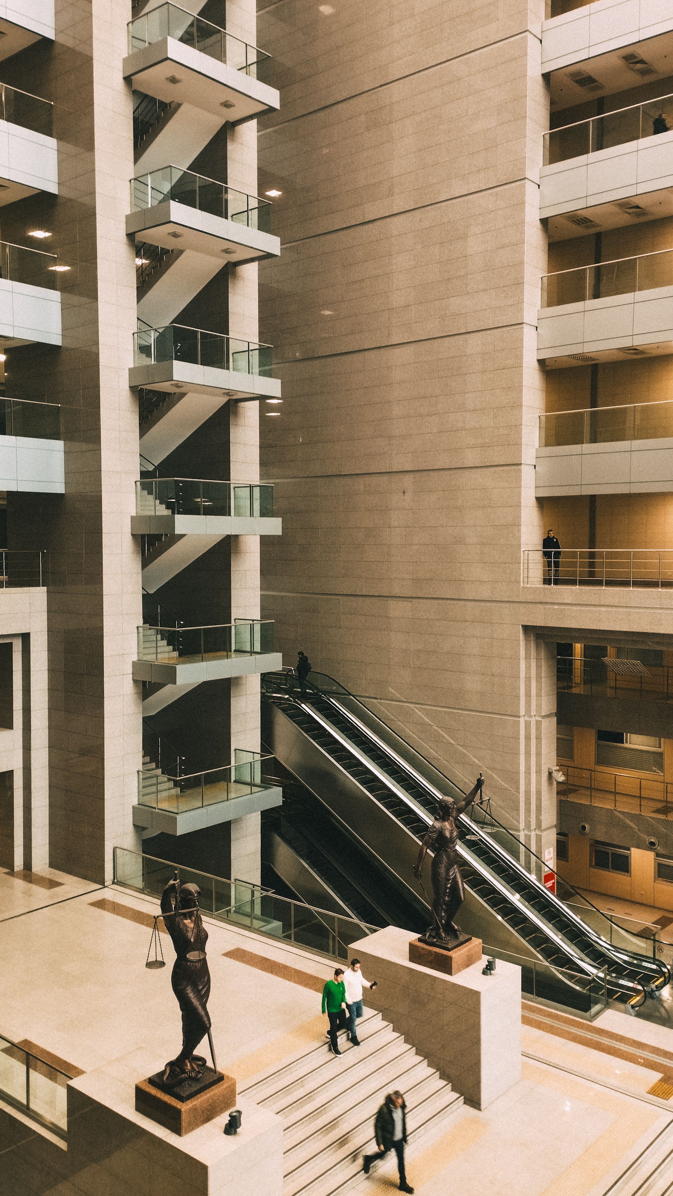 Modern Atrium with Escalators and Sculptures · Free Stock Photo