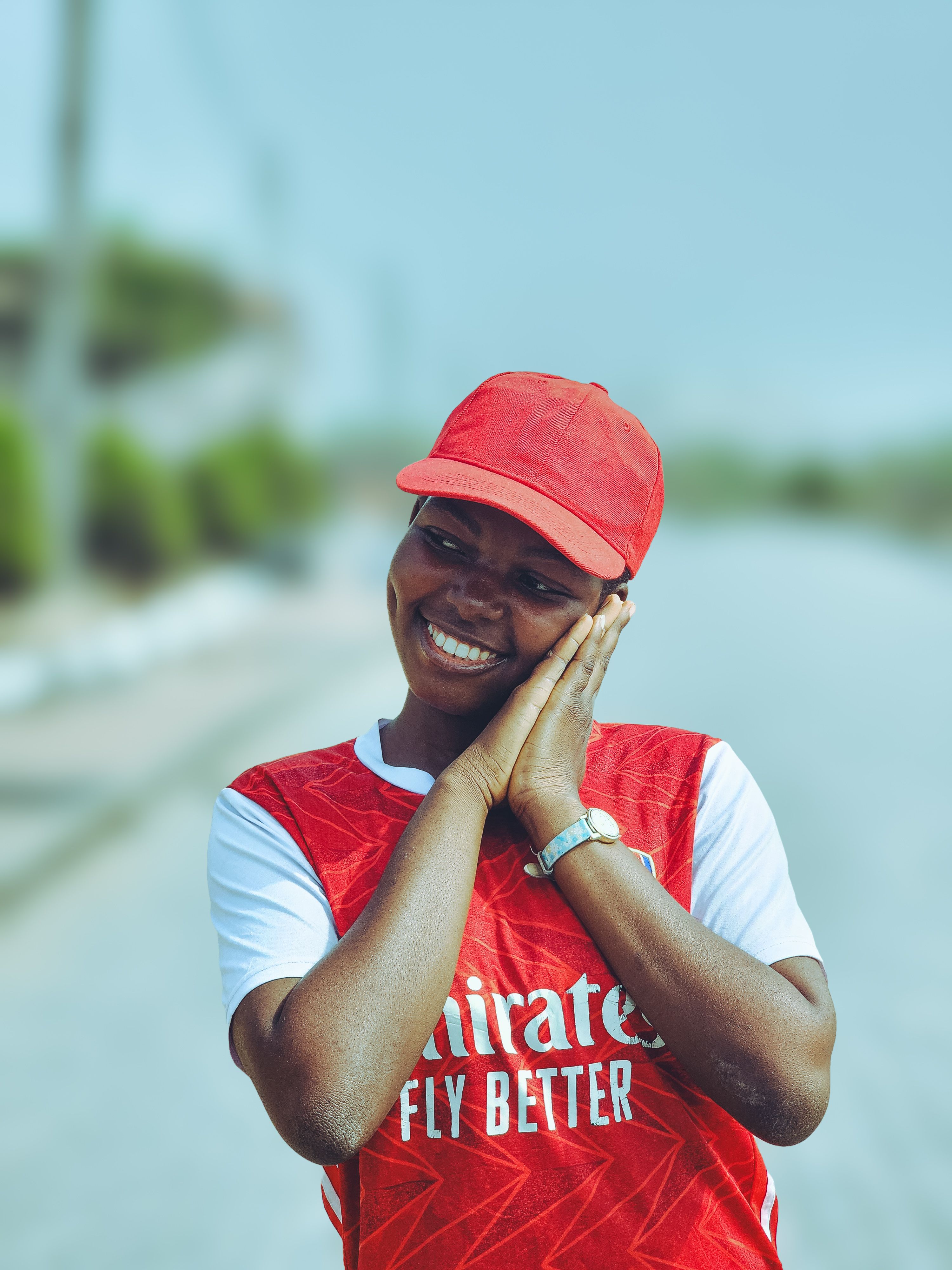 Smiling Woman in Red Sports Attire Outdoors · Free Stock Photo